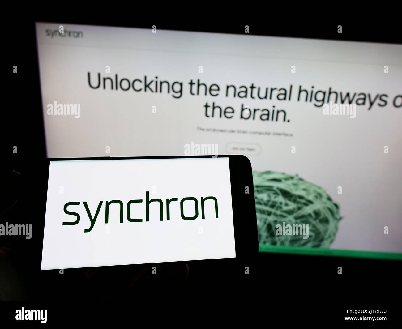 Person holding cellphone with logo of American brain interface company ...