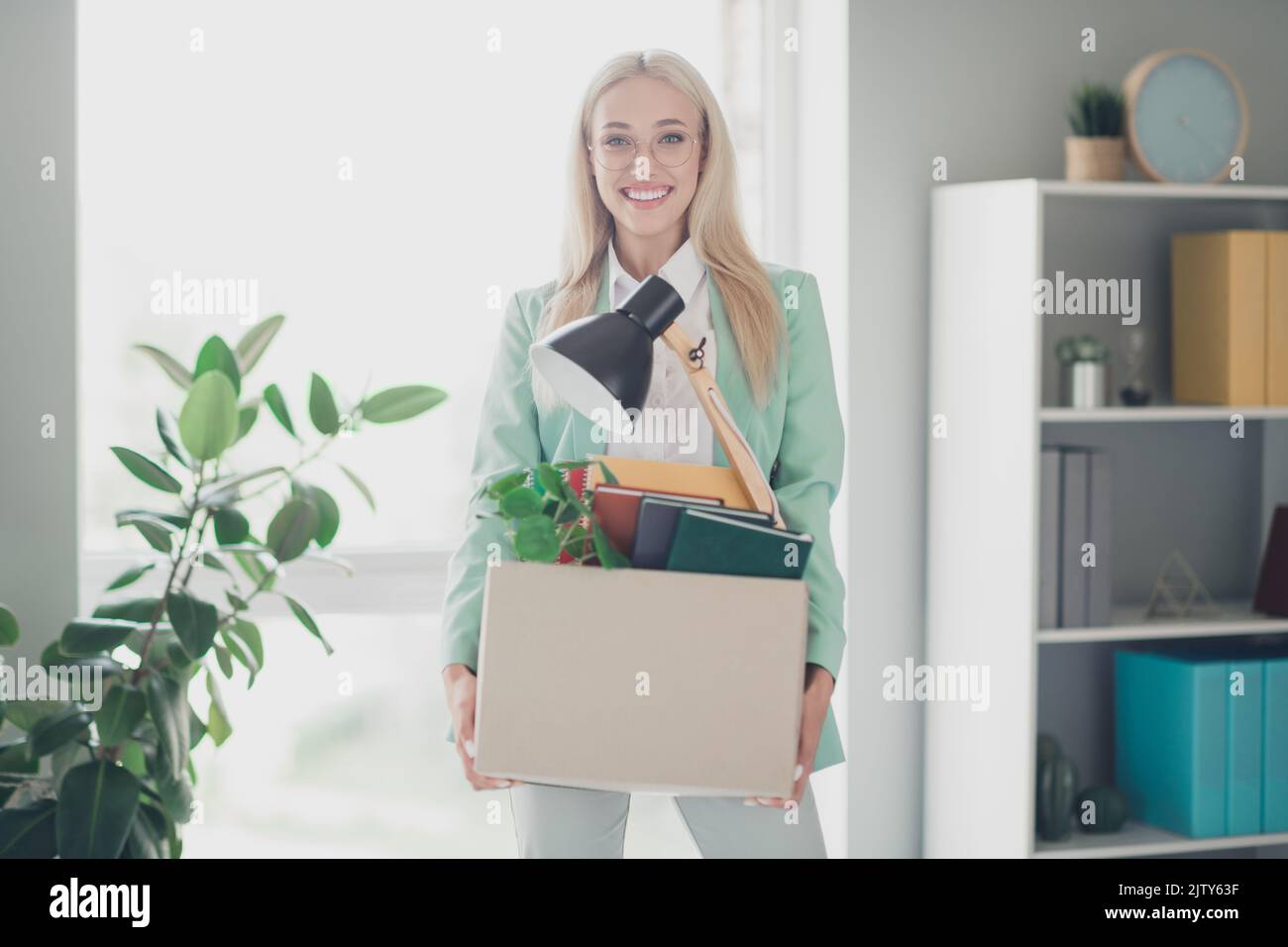 Photo of sweet charming lady wear turquoise jacket holding box staff ...