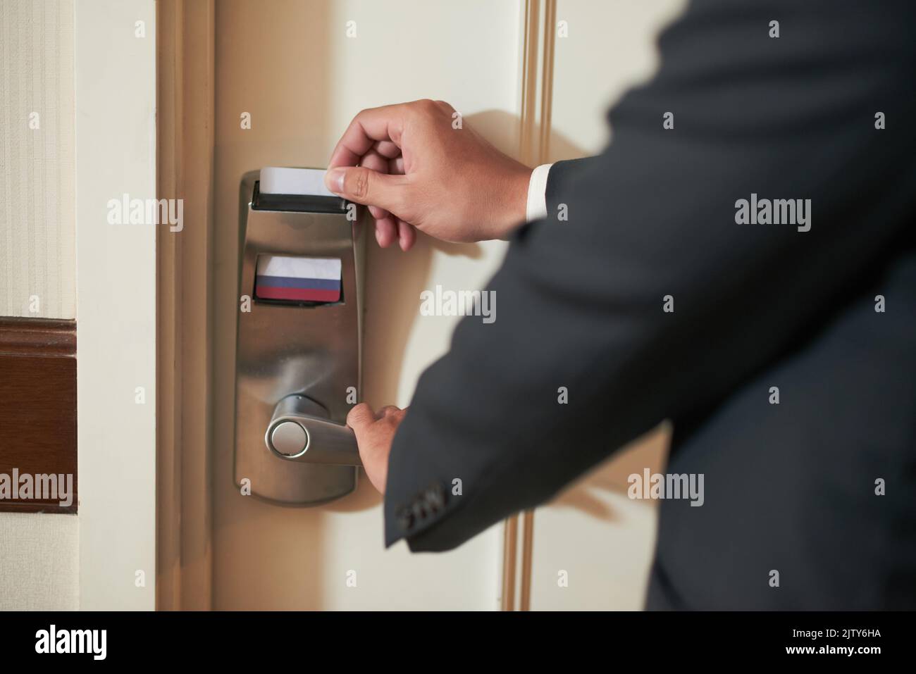 Man using electronic key to open room door Stock Photo - Alamy
