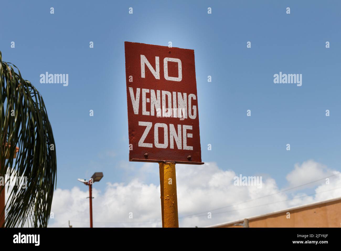 A red "No vending zone" sign against a blue sky background Stock Photo ...