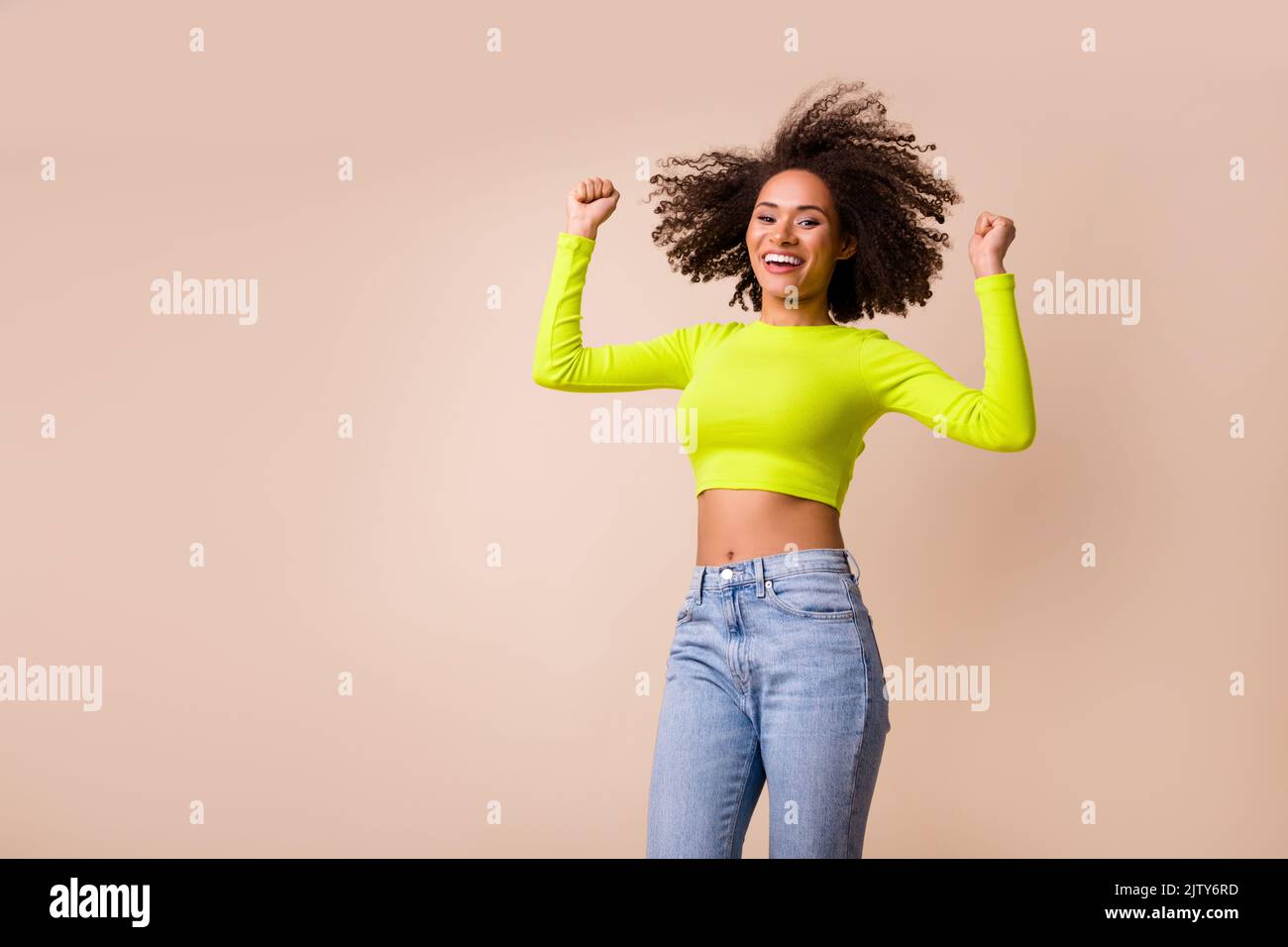 Portrait of young attractive skin girl wear bright yellow top celebrate ...