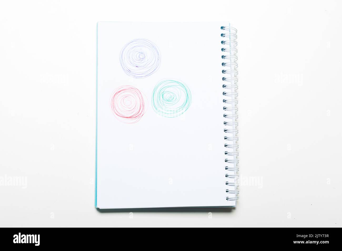Spiral white notepad with pen scribble isolated on white background ...