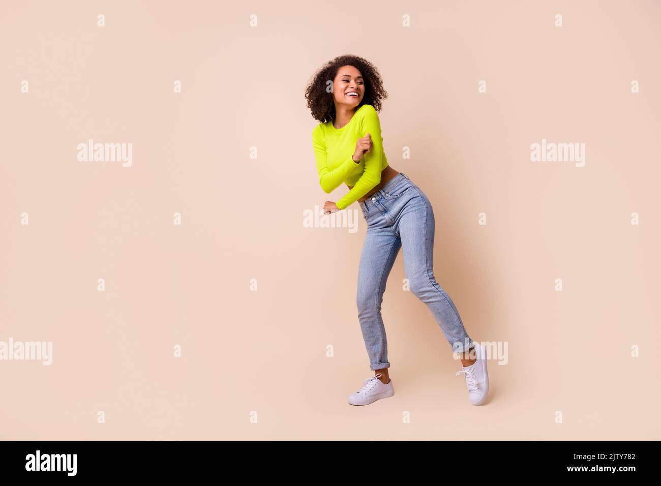 Full size photo of young smiling joy lady wear yellow top jeans dancing ...