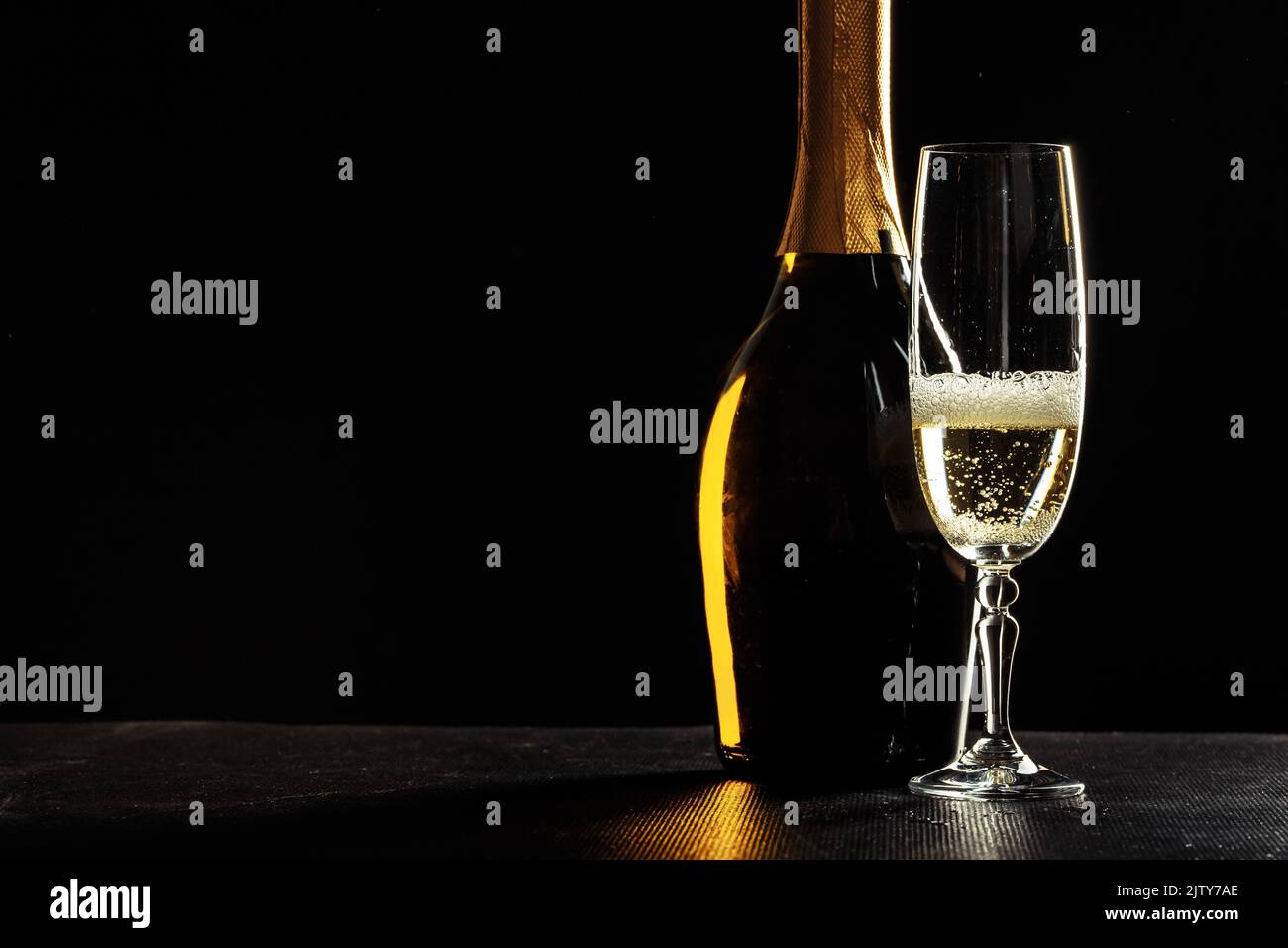bottle of champagne and glasses over dark background Stock Photo - Alamy