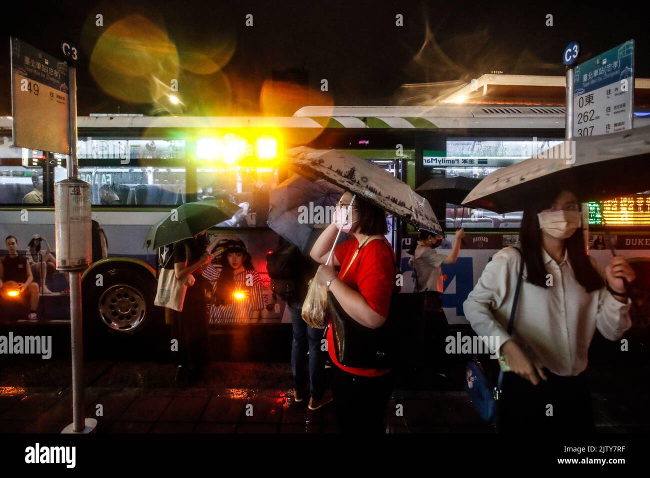 Taipei, Taipei, Taiwan. 2nd Sep, 2022. People holding up umbrellas wait ...