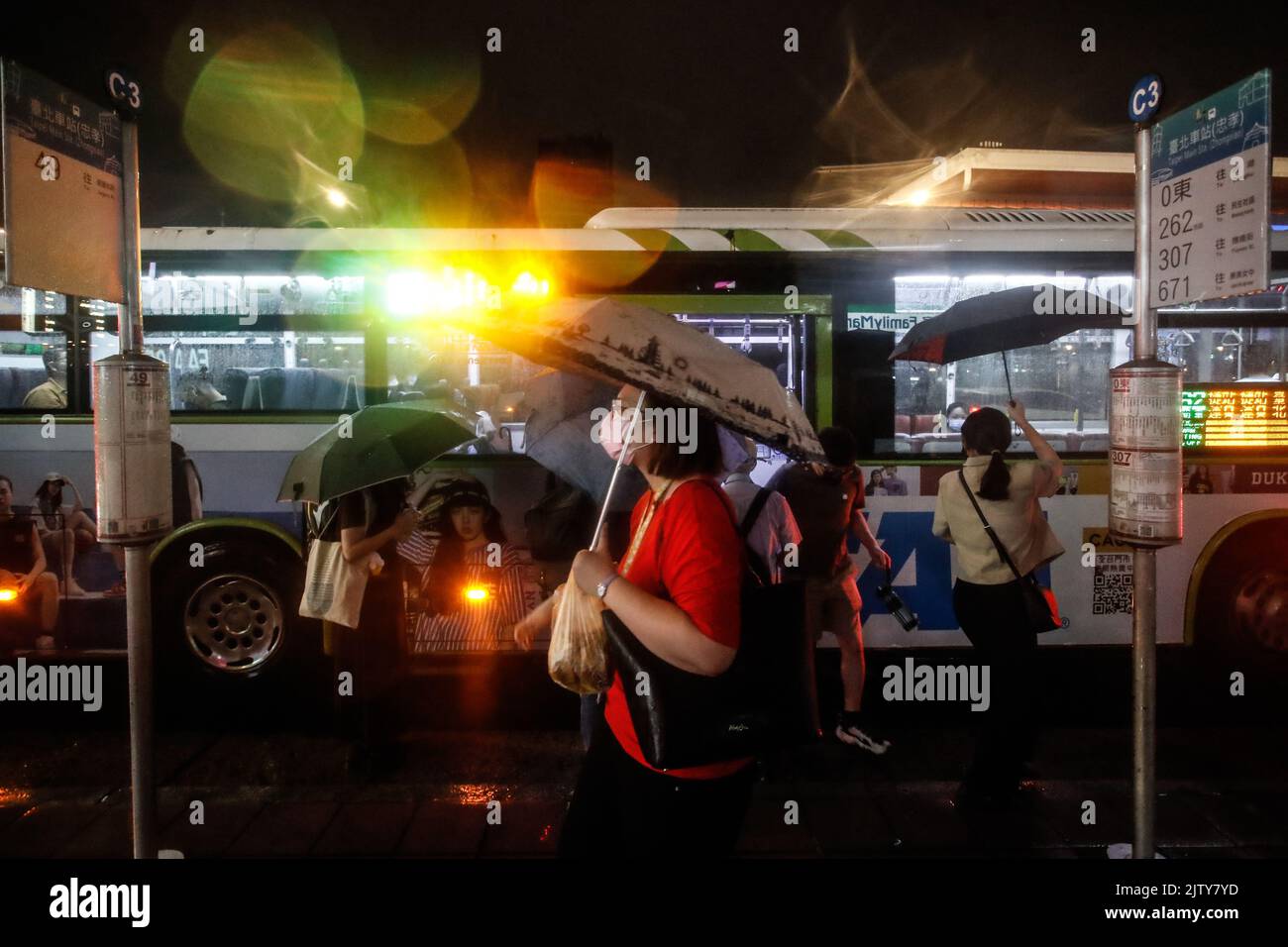 Taipei, Taipei, Taiwan. 2nd Sep, 2022. People holding up umbrellas wait ...