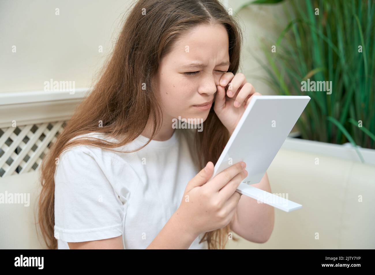 Portrait of teenage holding mirror and trying to pop pimple Stock Photo ...