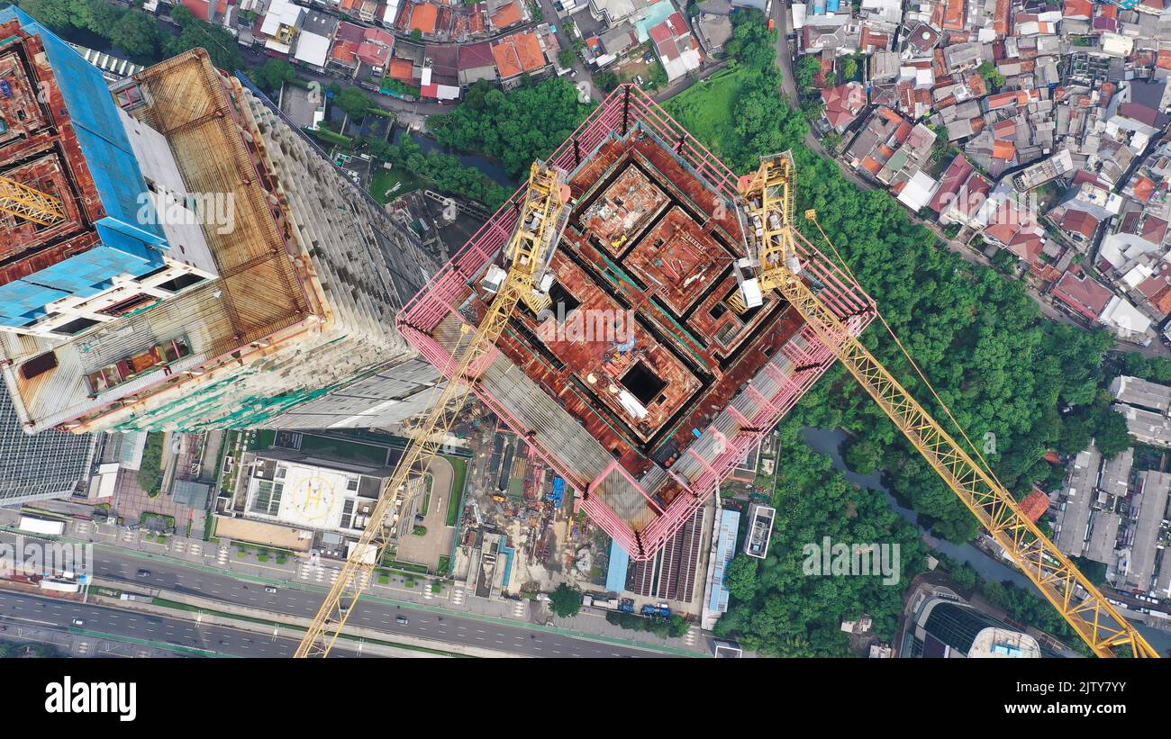 Hi-rise skeleton construction site with the yellow crane Stock Photo ...