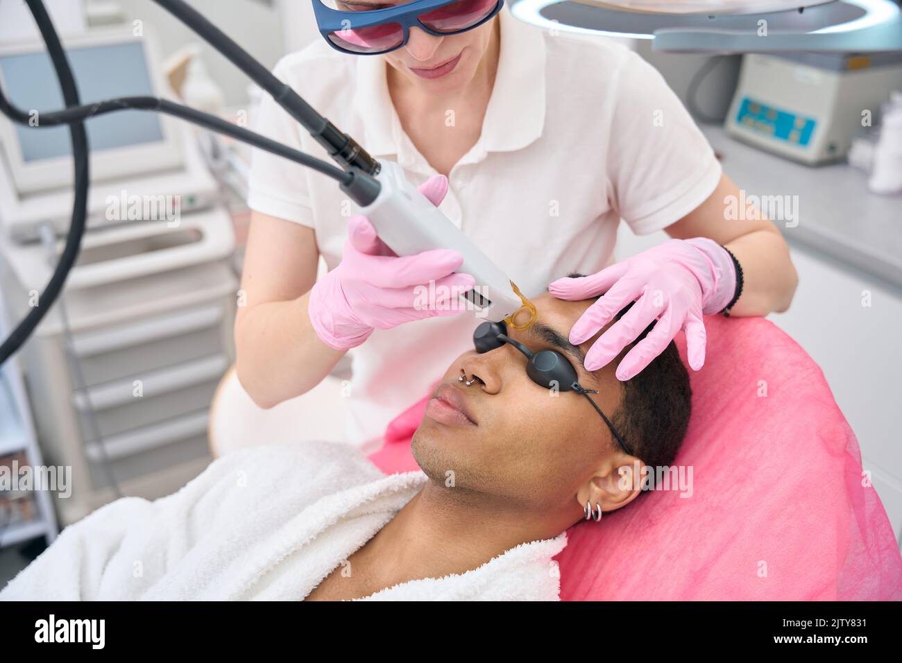 Professional male beautician performing hi-res stock photography and ...