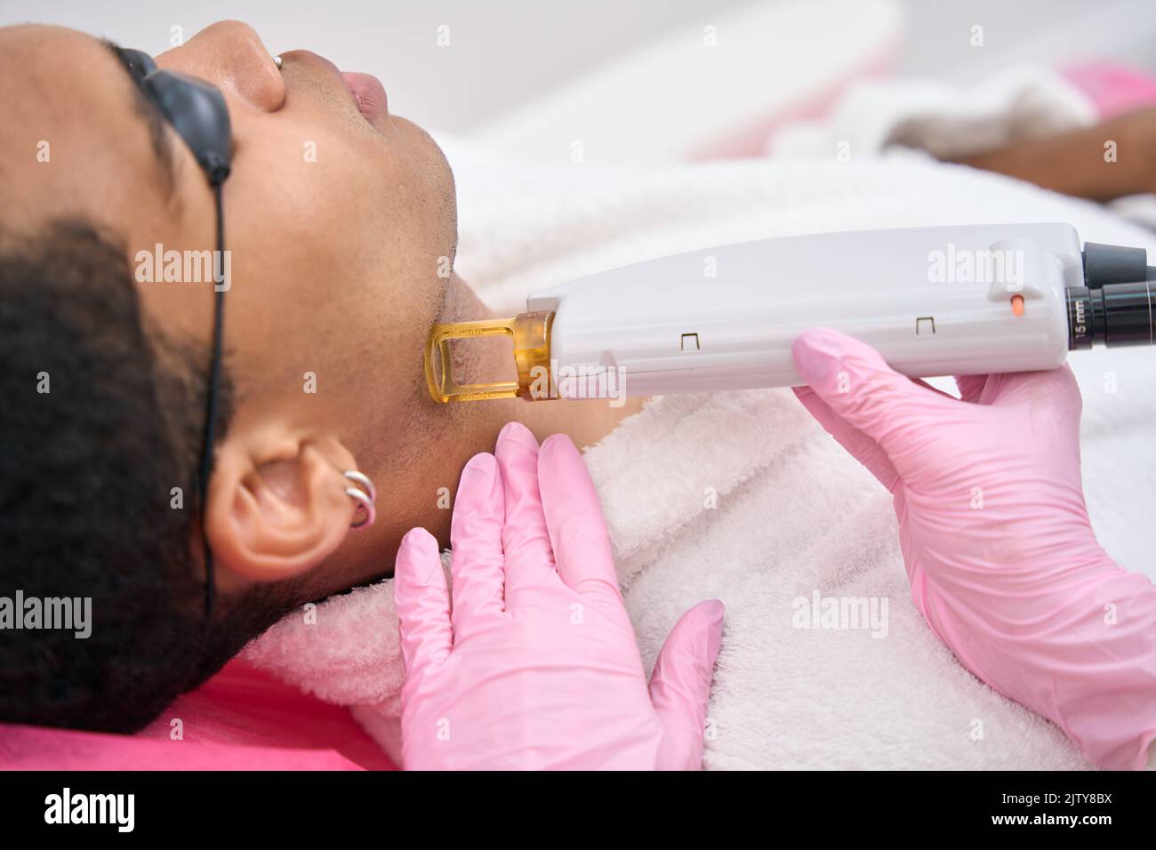 Beauty clinic client undergoing laser epilation procedure on skin Stock ...