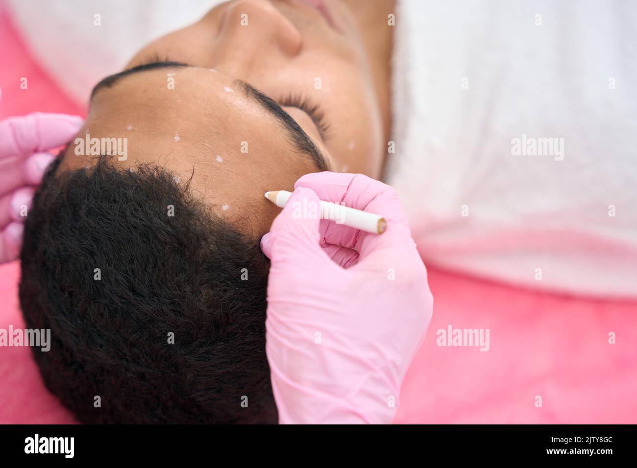 Professional beauty salon beautician preparing client for cosmetic ...