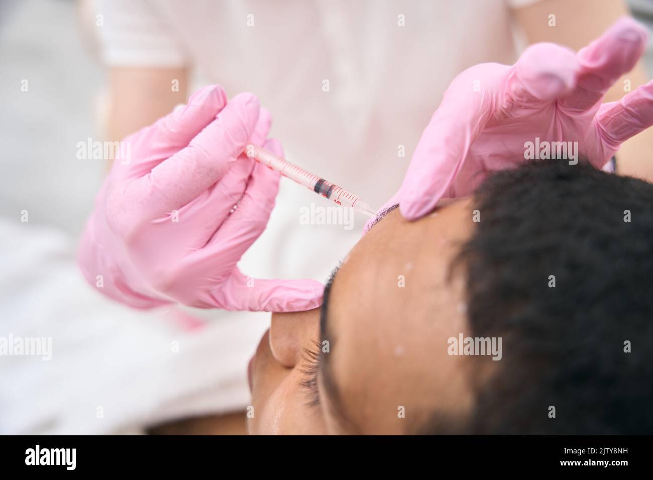 Esthetic medicine clinic client receiving dermal filler injection into ...