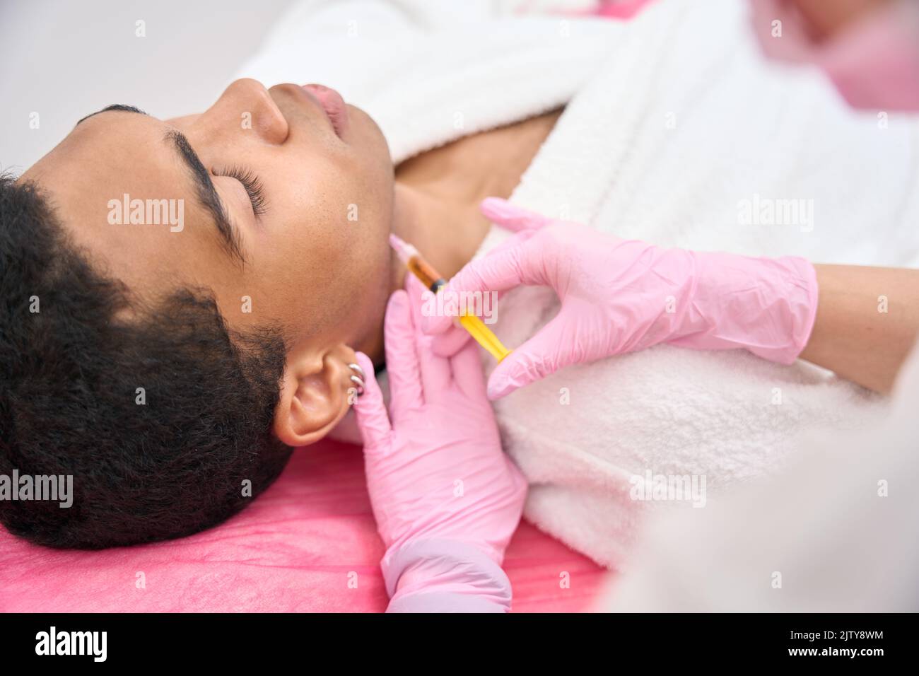 Man getting dermal filler injection into wrinkle on his neck Stock ...