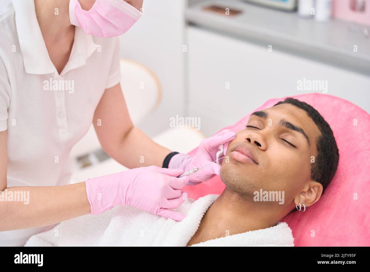 Male patient receiving dermal filler injection in aesthetic medicine ...