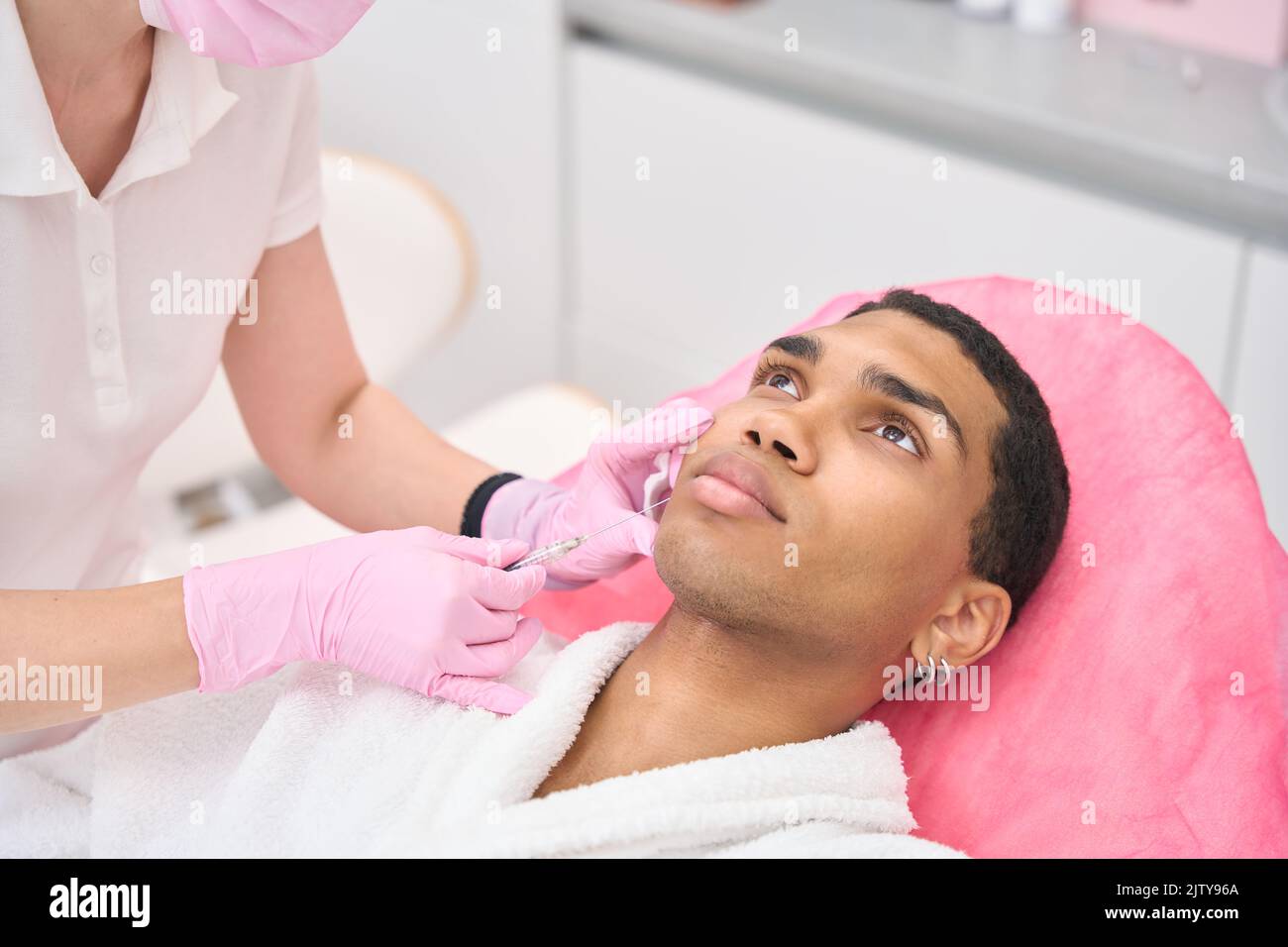 Patient getting dermal filler injection during cosmetic procedure Stock ...