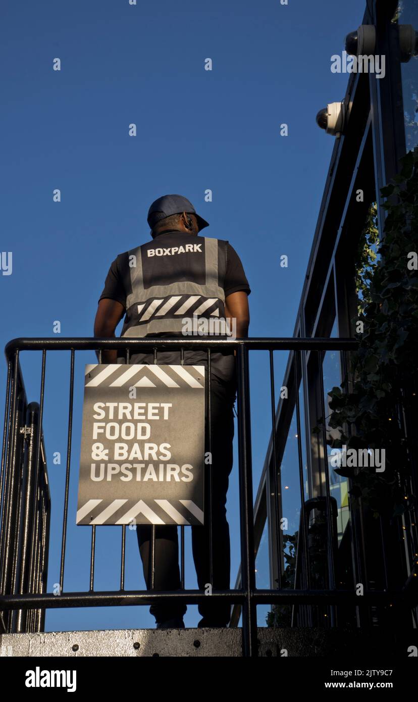 Security officer outside a bar in BoxPark, Shoreditch,London,England,UK ...
