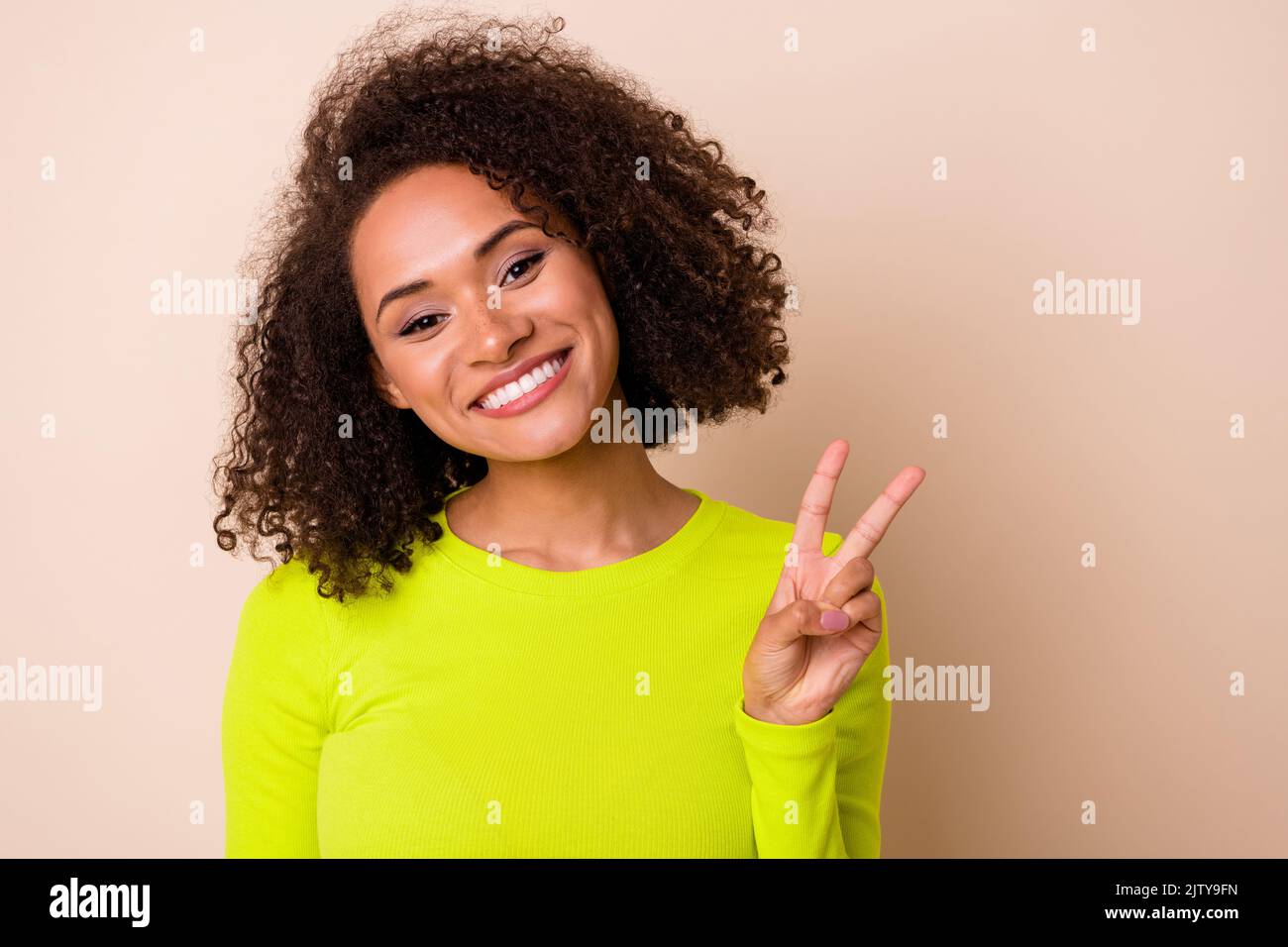Closeup photo of young happy lady wear yellow jumper showing v-sign new ...