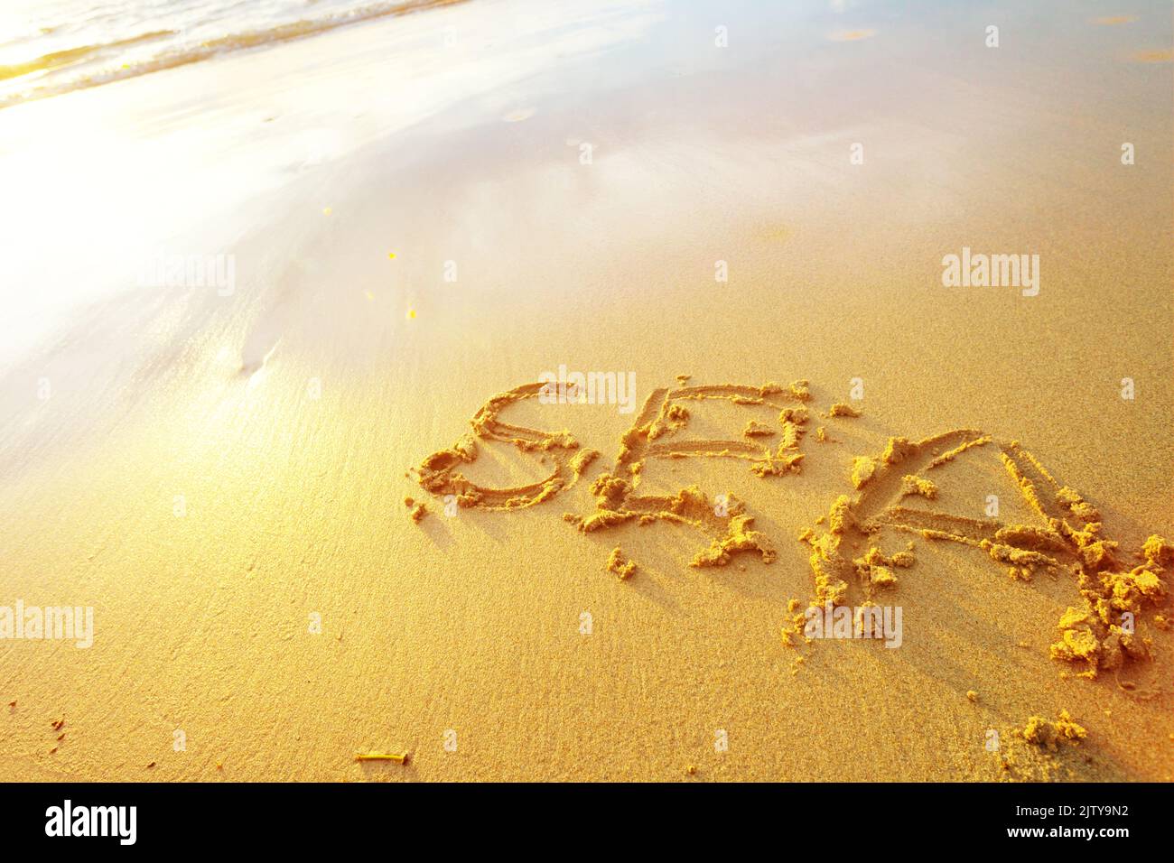 Sea letters handwritten in sand on beach Stock Photo - Alamy