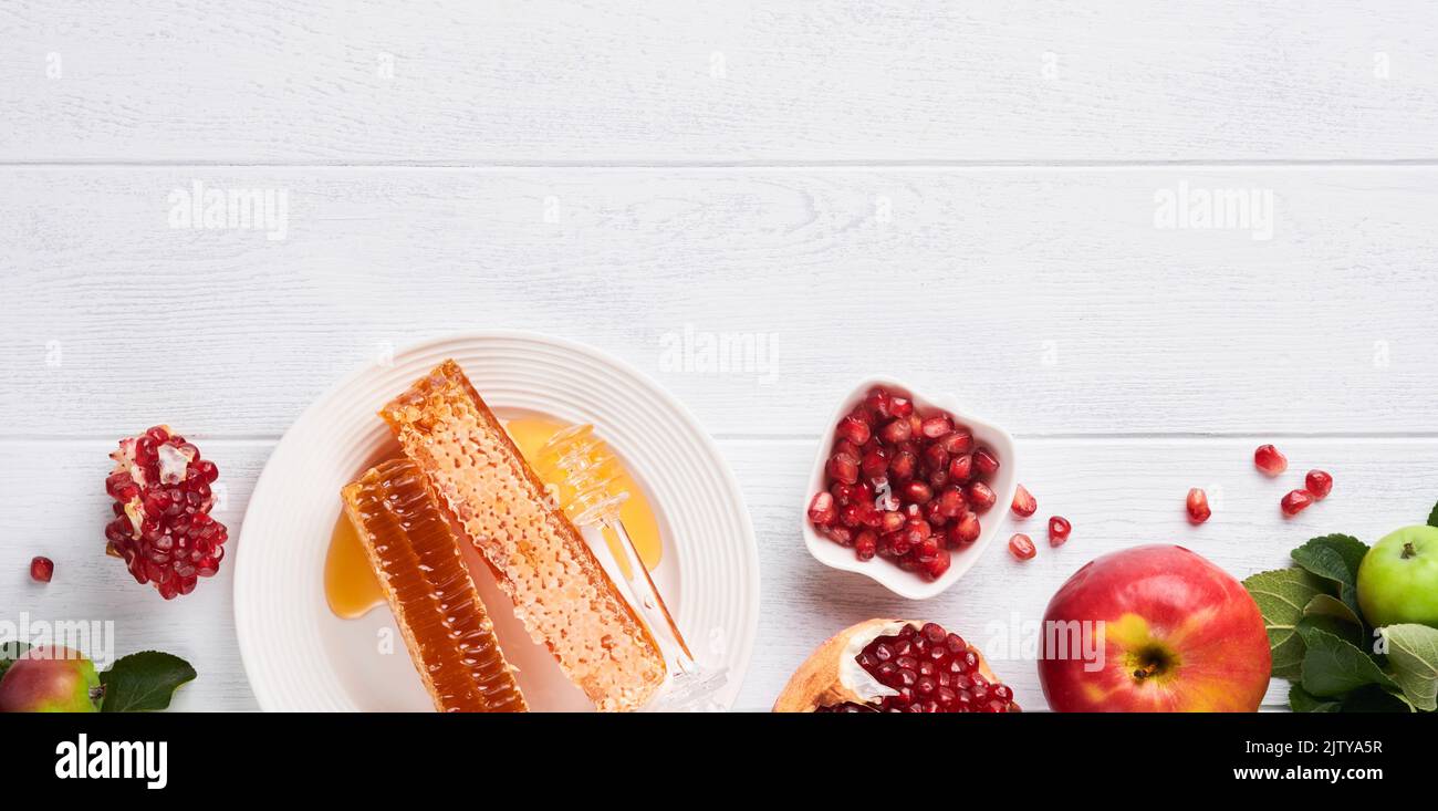 Rosh Hashanah. Honey jar, honeycomb, apple and pomegranate on white ...