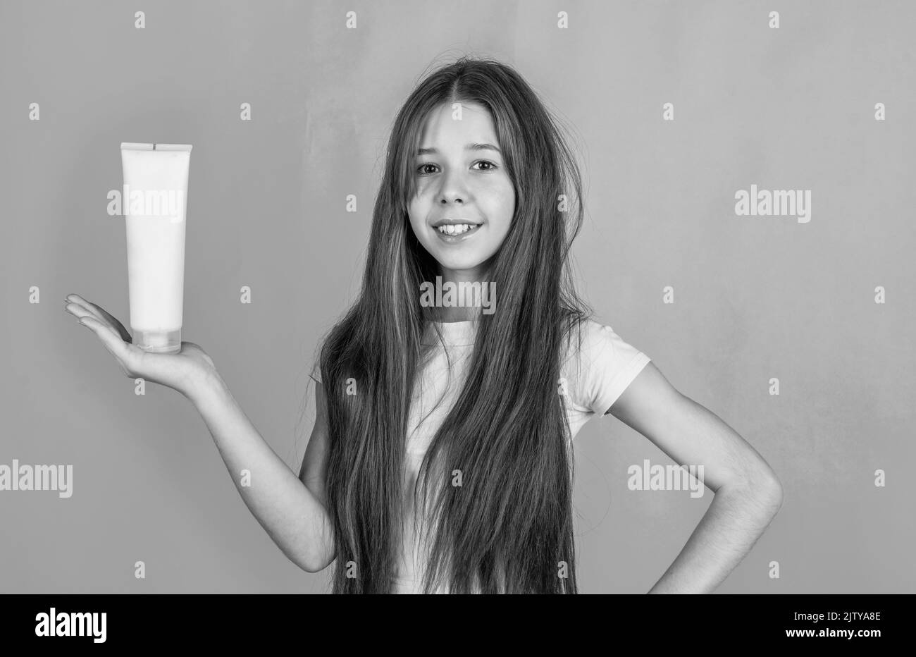 wash and rinse. happy teen girl presenting cosmetic product. shampooing ...