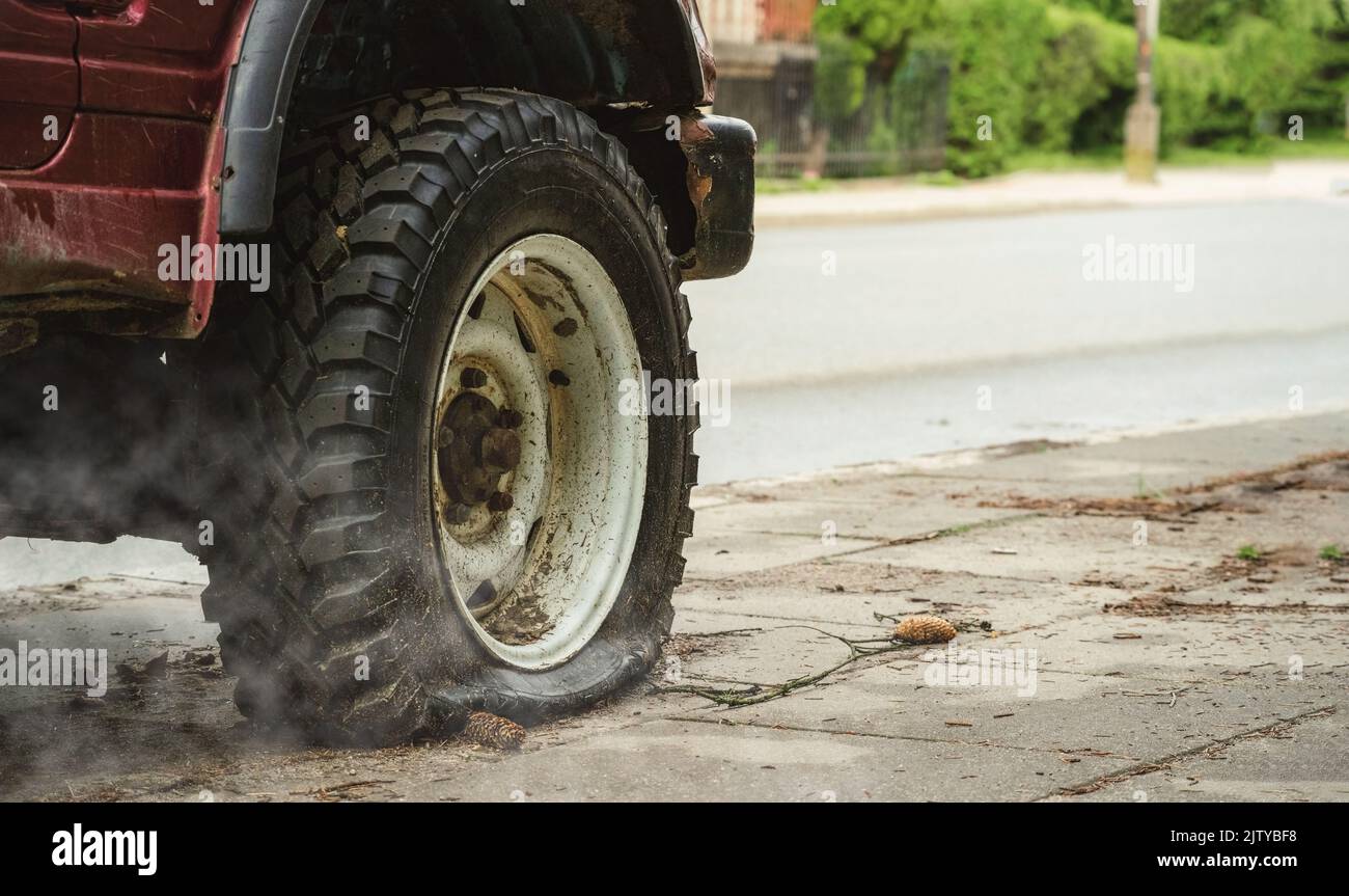 Punctured or flat suv off road car smoking or burnout tire during a ...