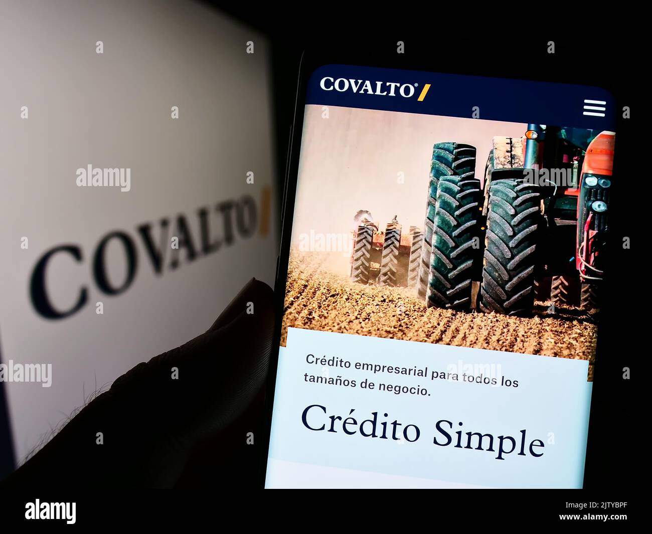 Person holding cellphone with webpage of Mexican banking company Banco ...