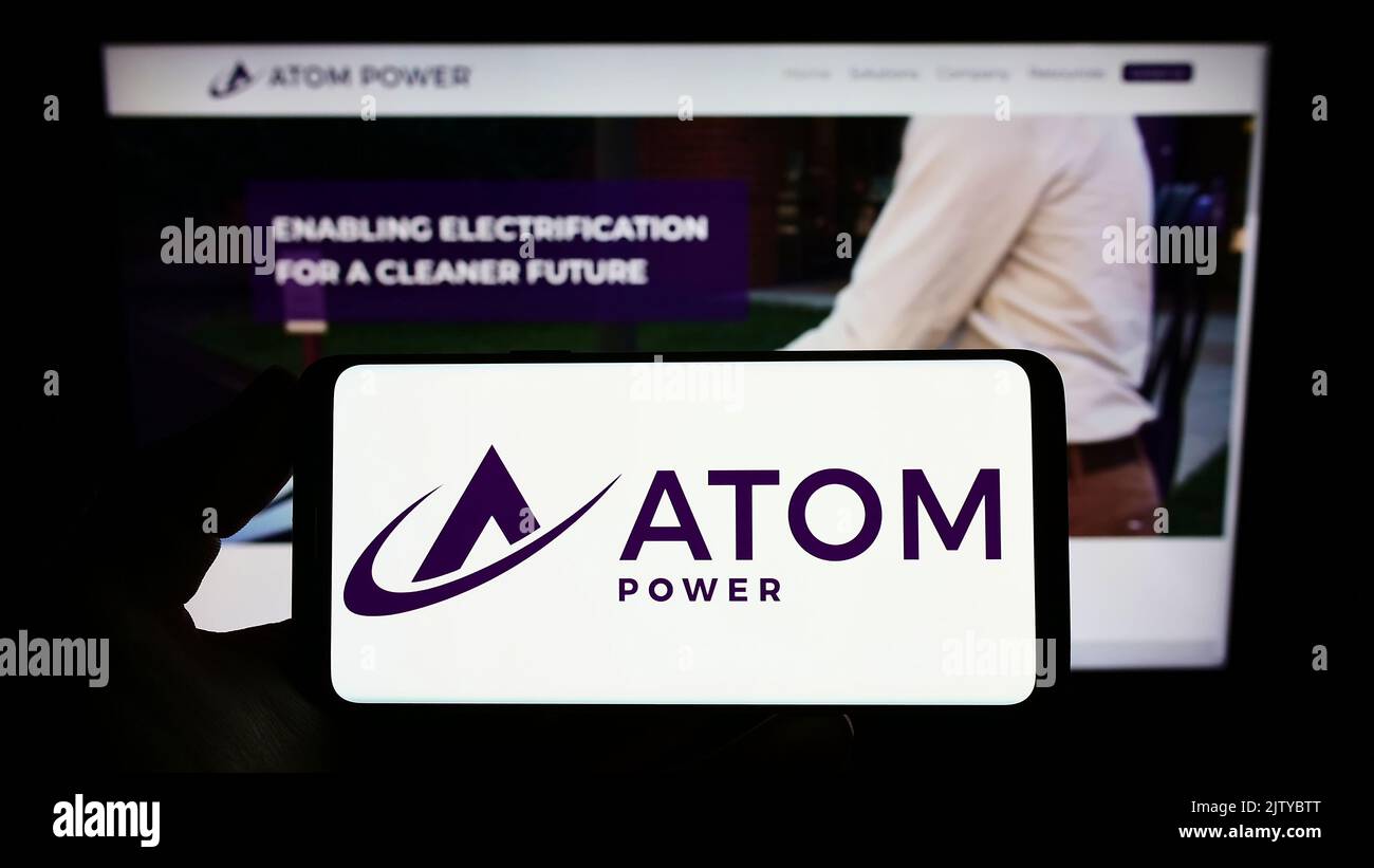 Person holding smartphone with logo of US electric charging company ...