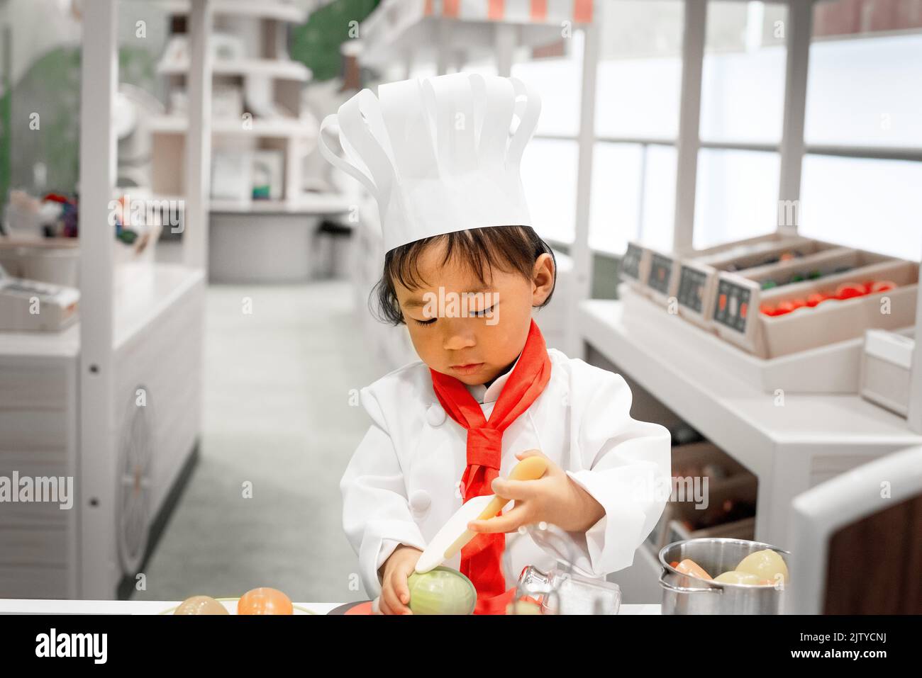 A toddler chef play pretend. Chef cook costume attire. Asian-Filipino ...