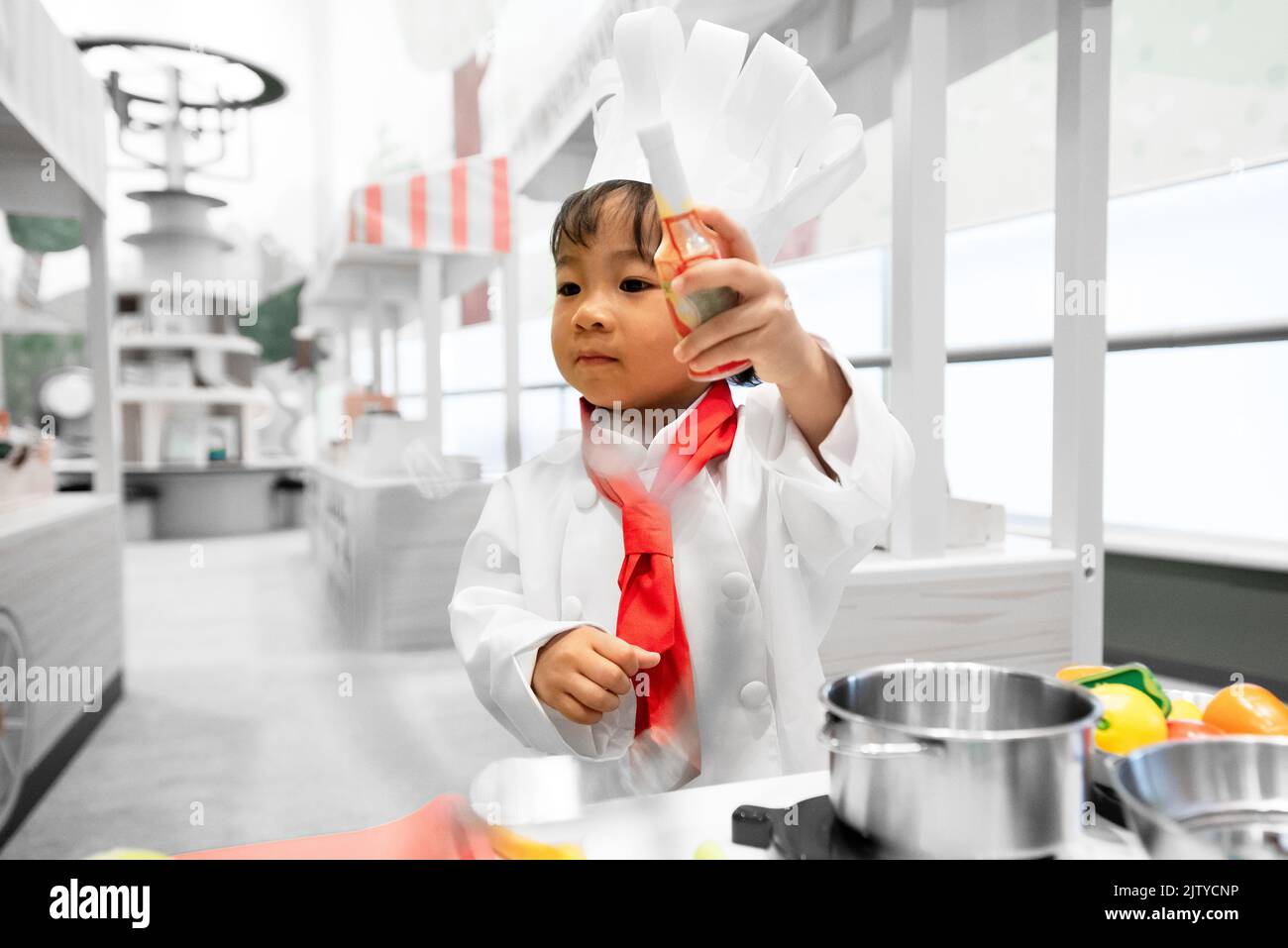 A toddler chef play pretend. Chef cook costume attire. Asian-Filipino ...