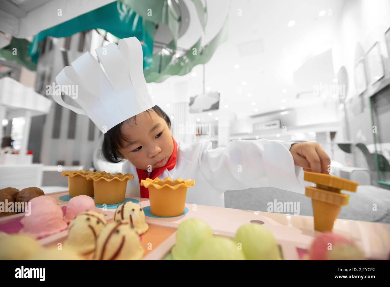 A toddler chef play pretend. Chef cook costume attire. Asian-Filipino ...