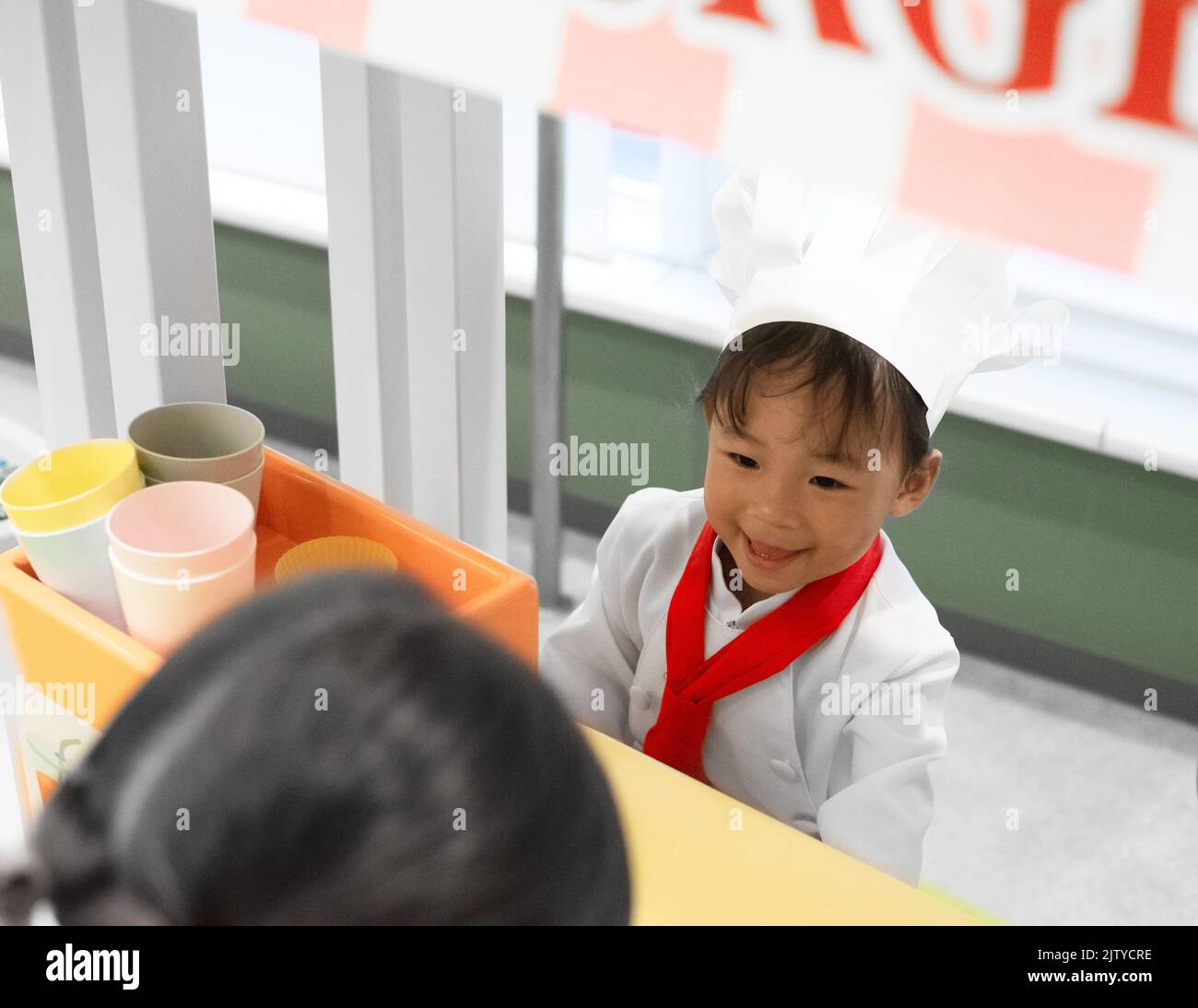 A toddler chef play pretend. Chef cook costume attire. Asian-Filipino ...