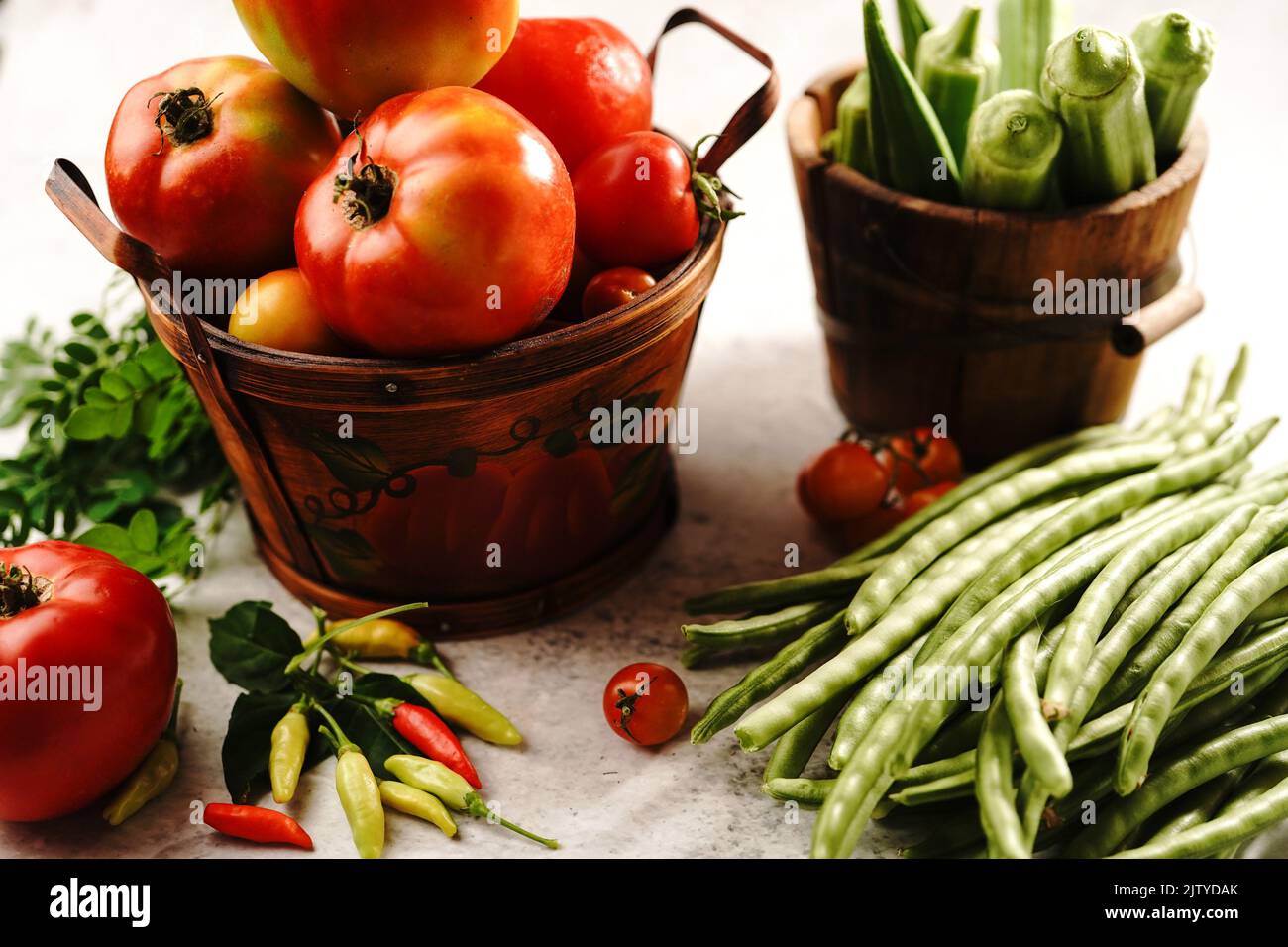 Still life of fresh homegrown vegetables cherry tomatoes green beans ...