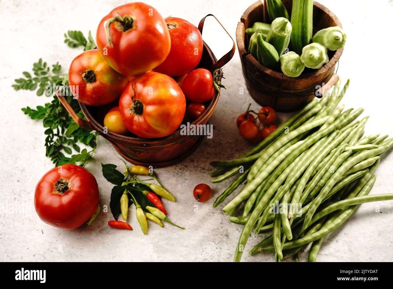 Still life of fresh homegrown vegetables cherry tomatoes green beans ...