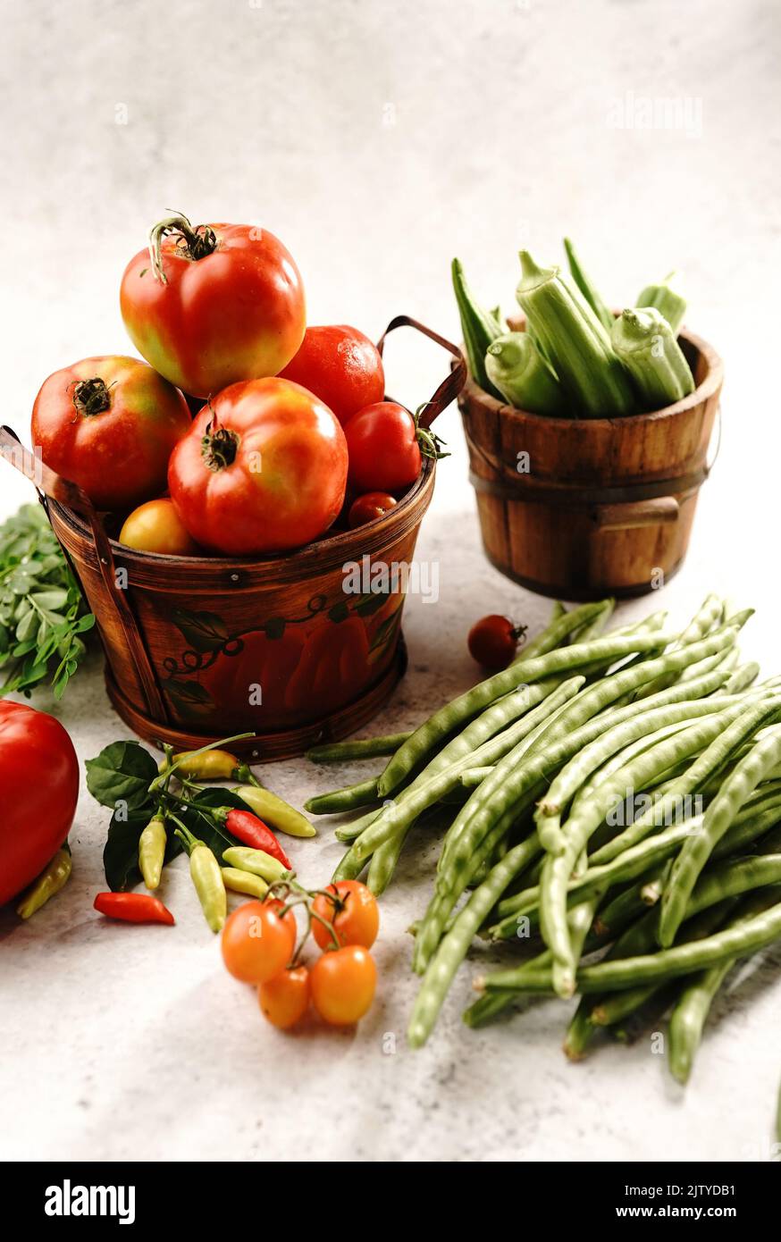 Still life of fresh homegrown vegetables cherry tomatoes green beans ...