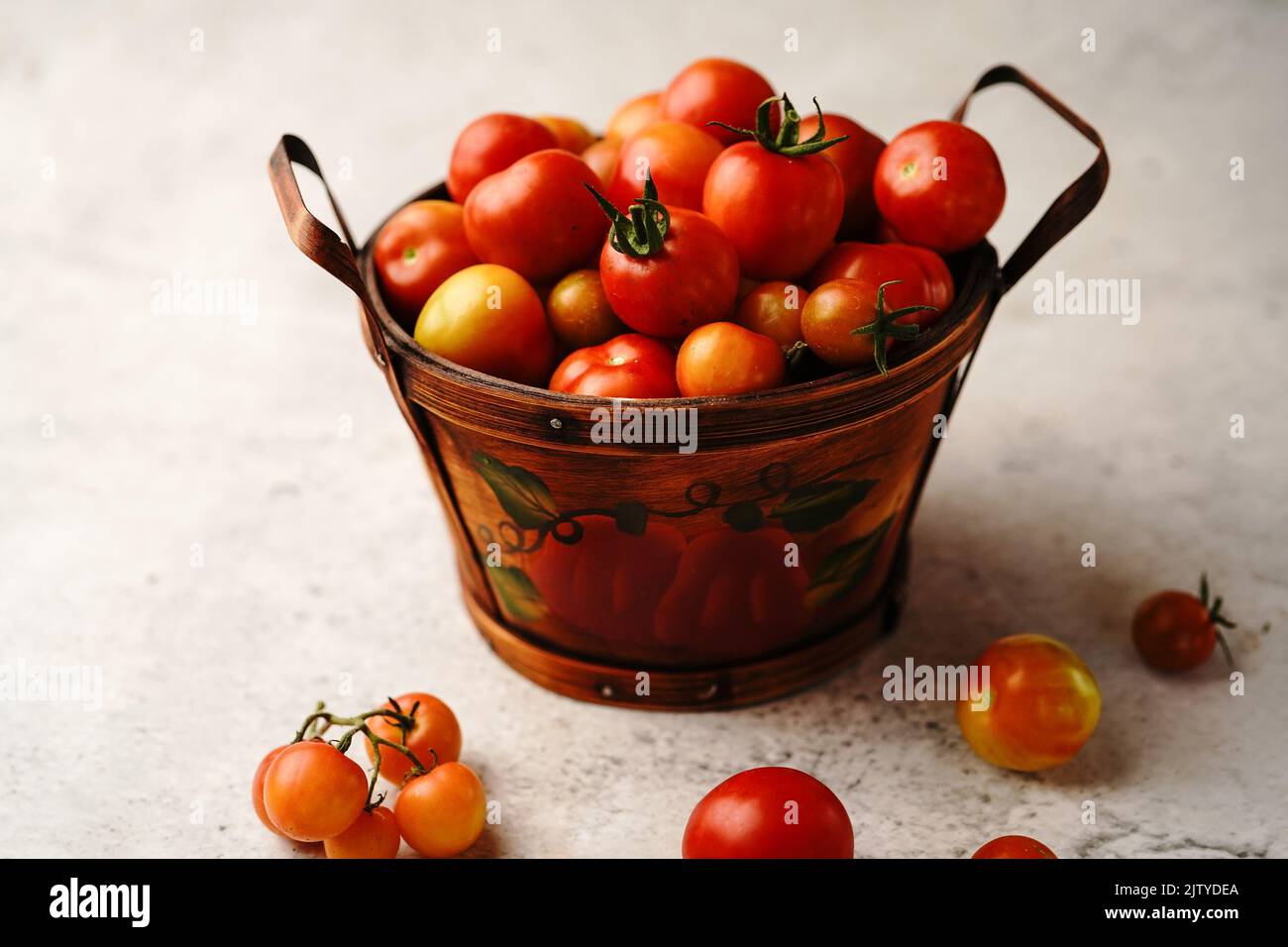 Still life of homegrown fresh cherry tomotoes in a basket with copy space Stock Photo - Alamy