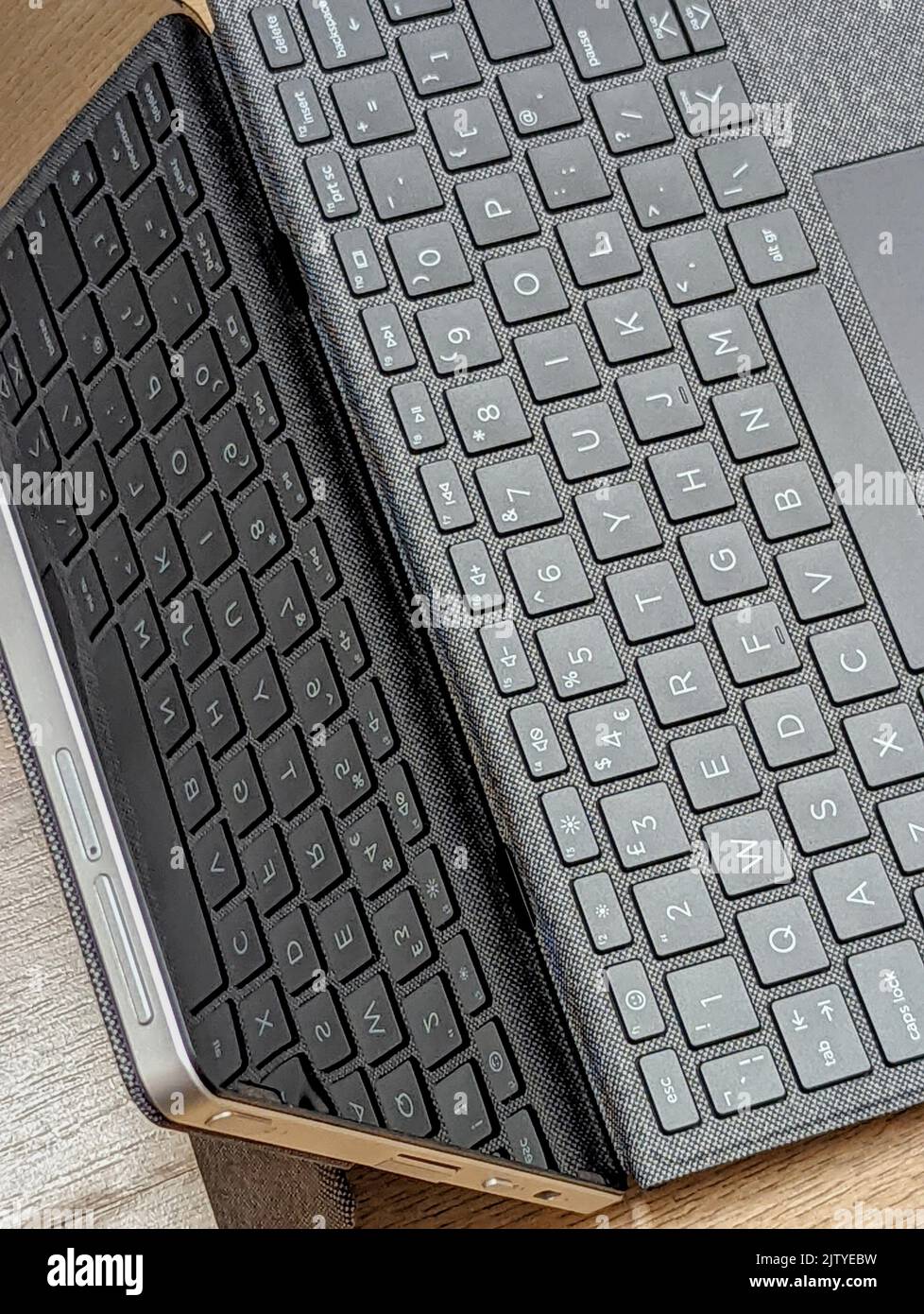 A top view of the keyboard of notebook and its reflection on the screen ...