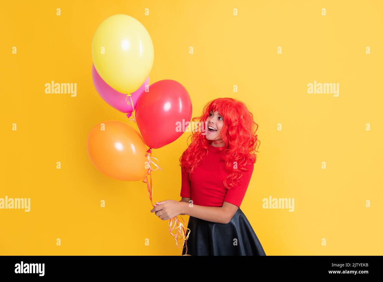 positive child with party balloon on yellow background Stock Photo - Alamy