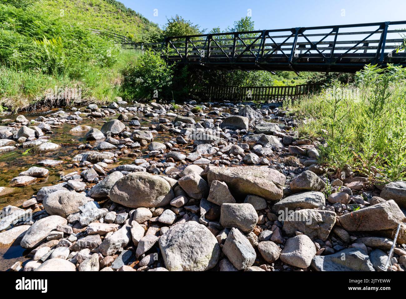 a river of rocks passing under two different bridges in nature Stock ...