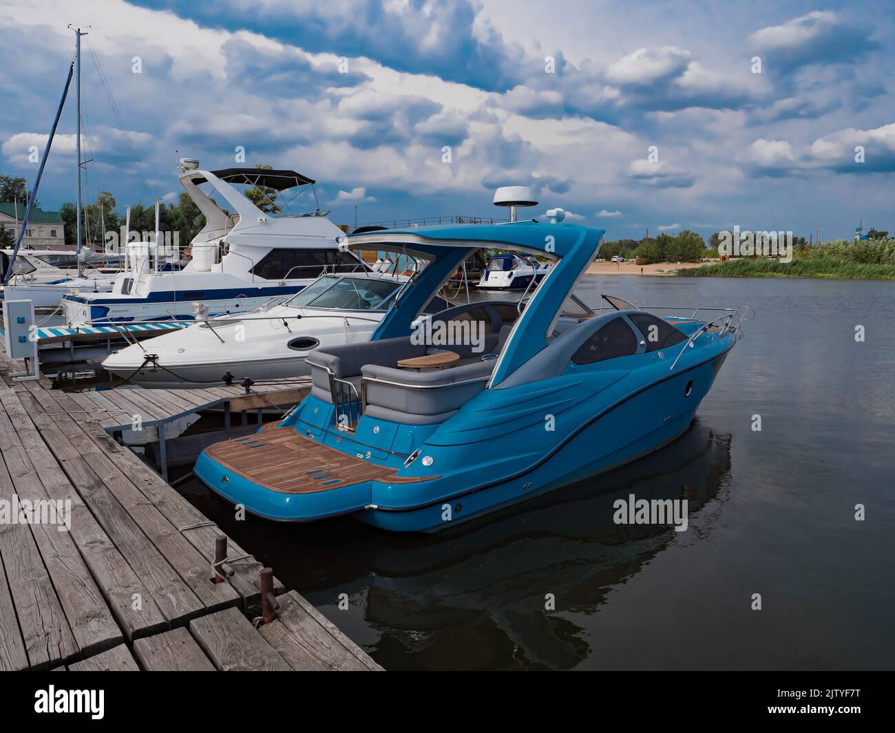 Boats moored to a pier in a yacht marina. Summer vacations and tourism ...