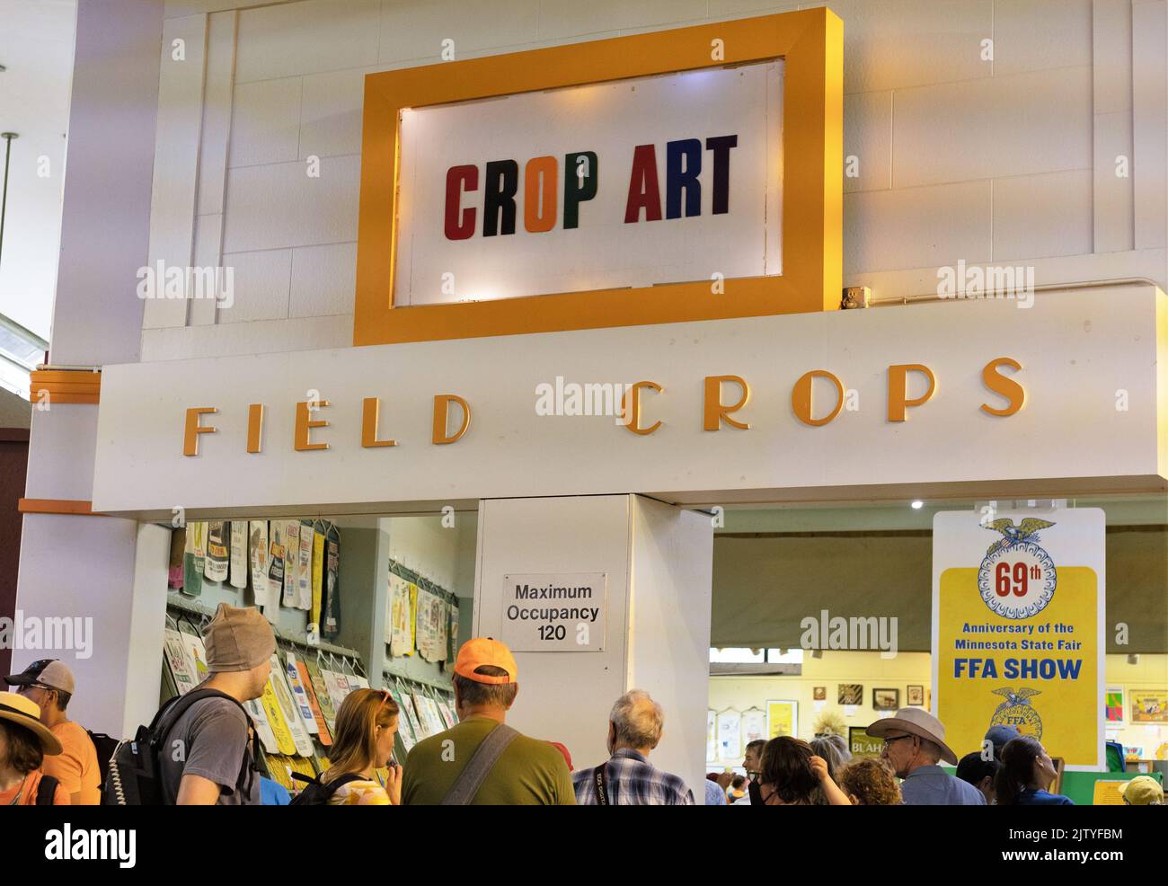 A crowd of people wait in line to see the popular crop art (seed art ...
