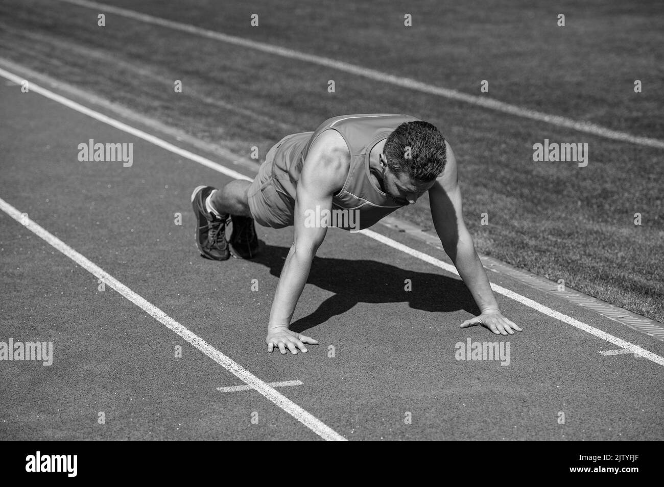 muscular guy stand in plank making push up on sport training, strength ...