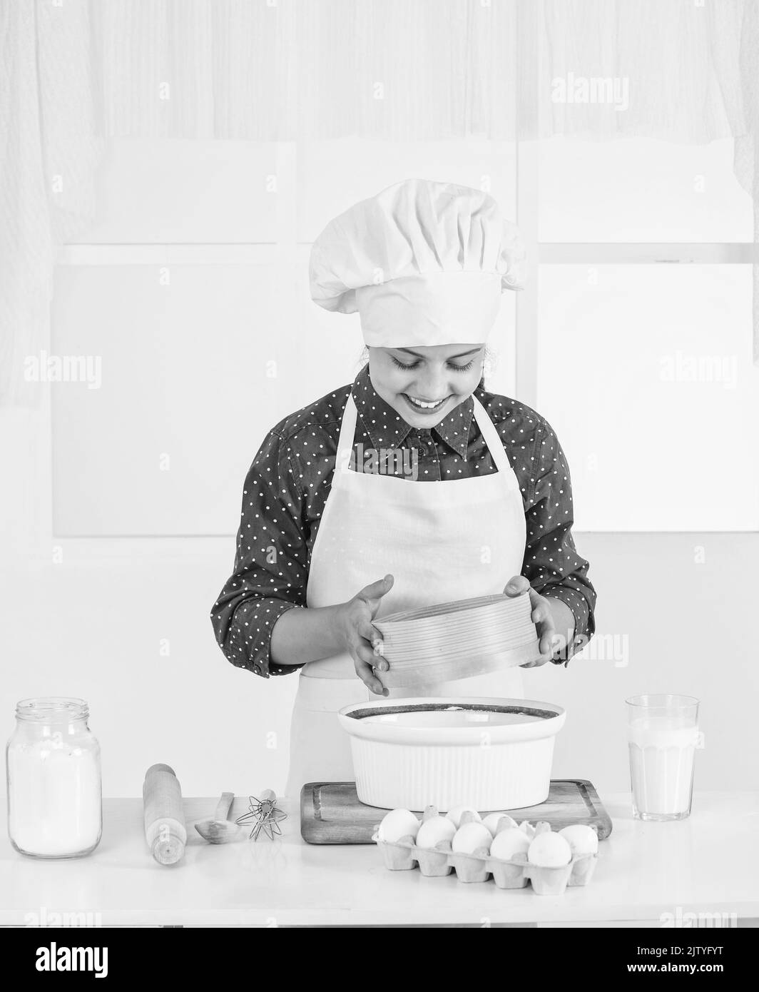 Look whats cooking. happy teen girl cooking dough. kid in chef uniform ...