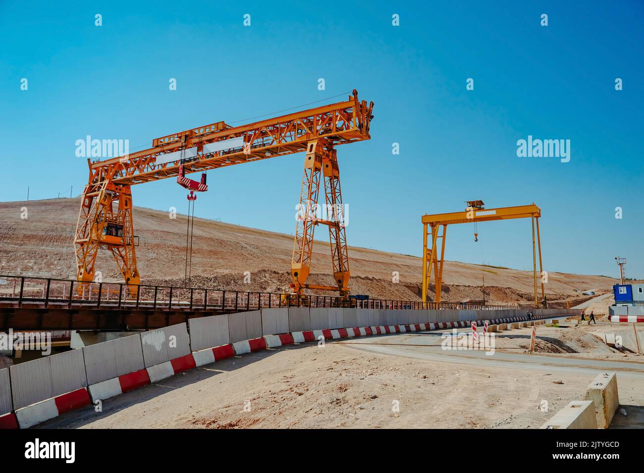 Two gantry cranes on highway construction. Big yellow gantry cranes ...