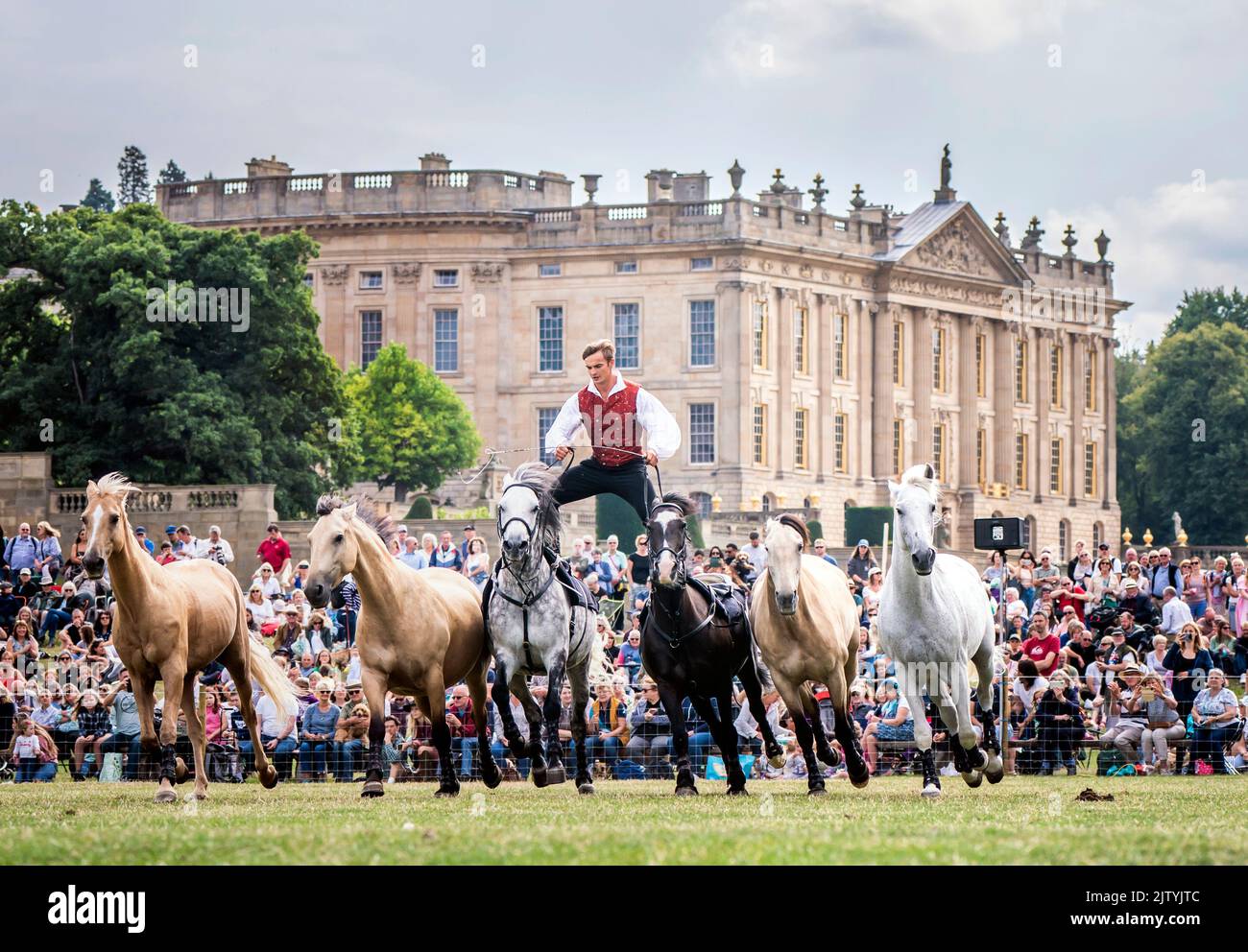 A member of Atkinson Action Horses performs over Chatsworth House ...