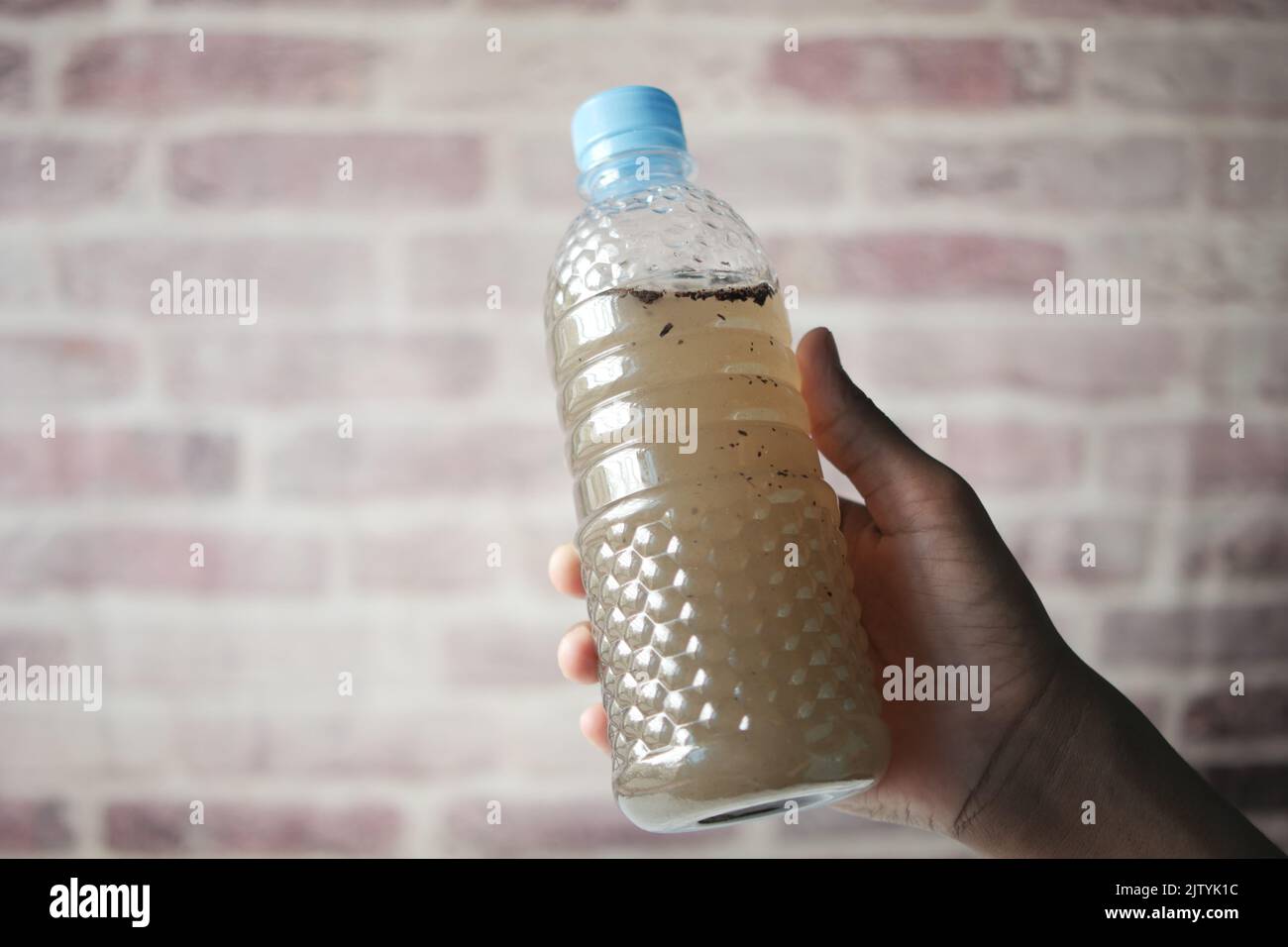 holding dirty bottle of water Stock Photo - Alamy