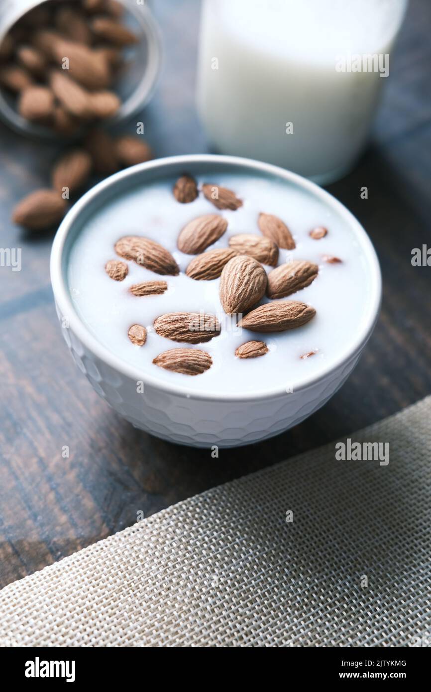 slow motion of pouring almond nuts in a milk Stock Photo - Alamy
