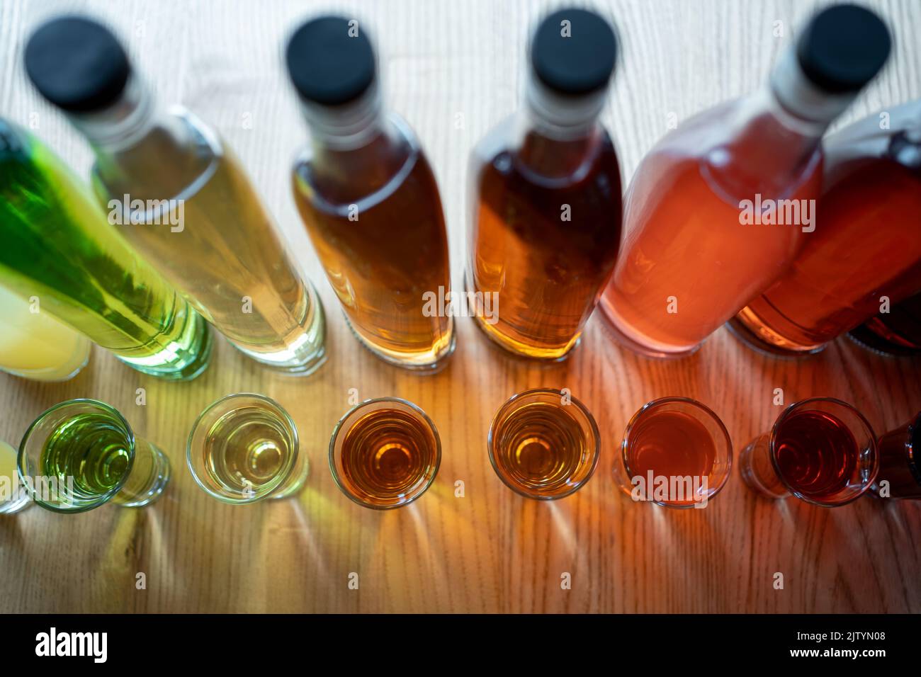 collection set of colored alcohol tincture or liquor with shot glass ...