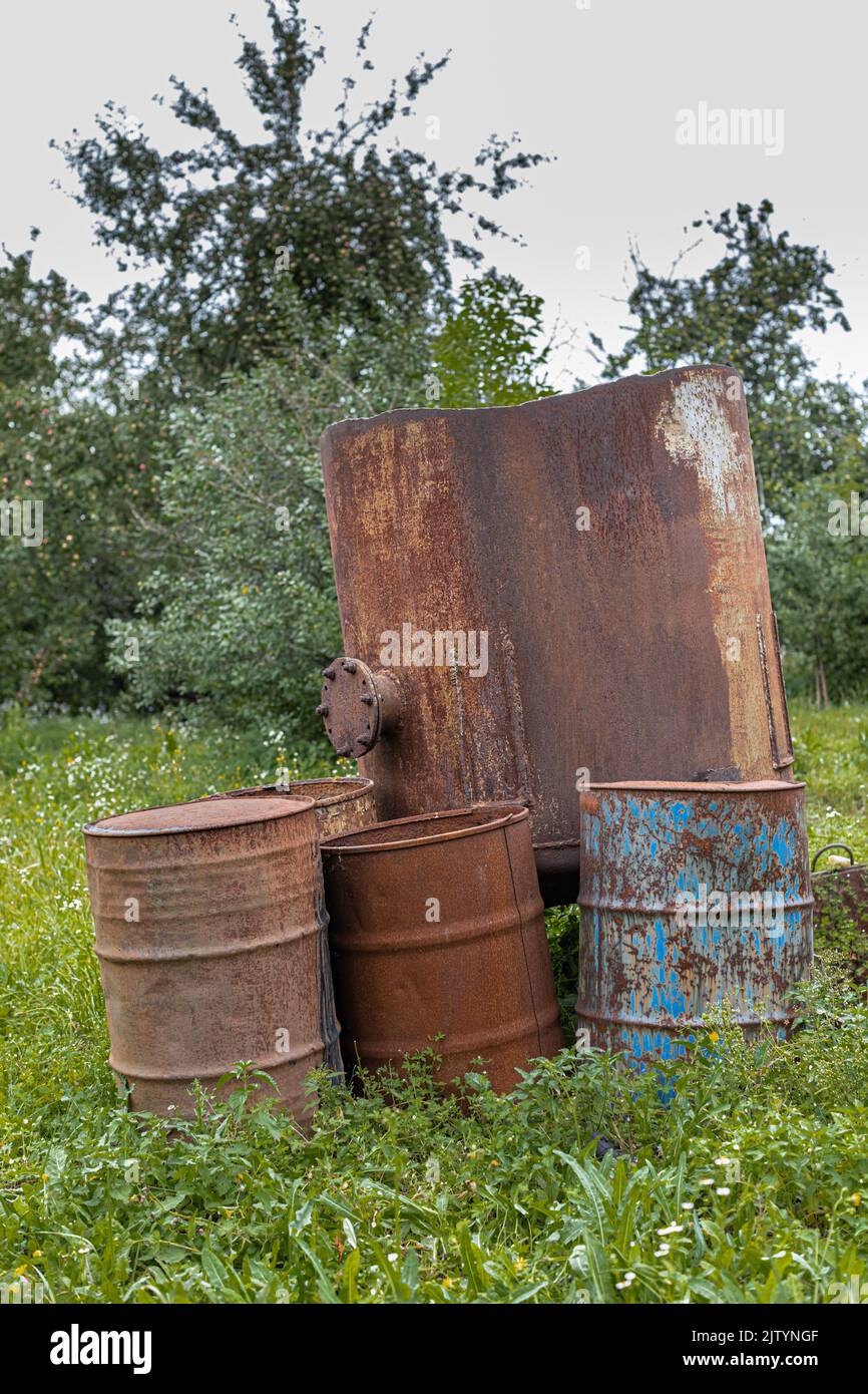 old metal rusty barrel stands in the garden Stock Photo - Alamy
