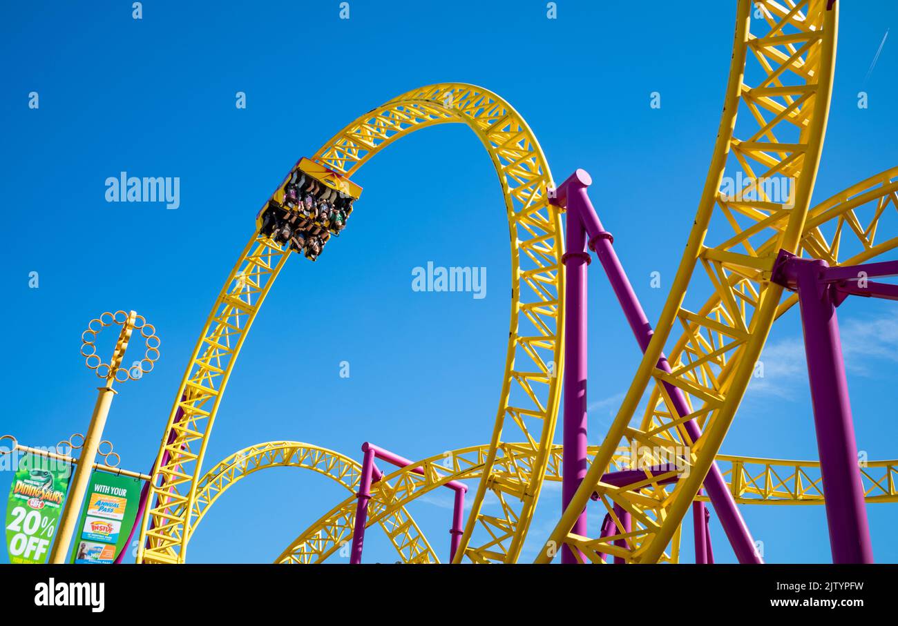 People travel upside down on a roller coaster ride called "Rage" at ...