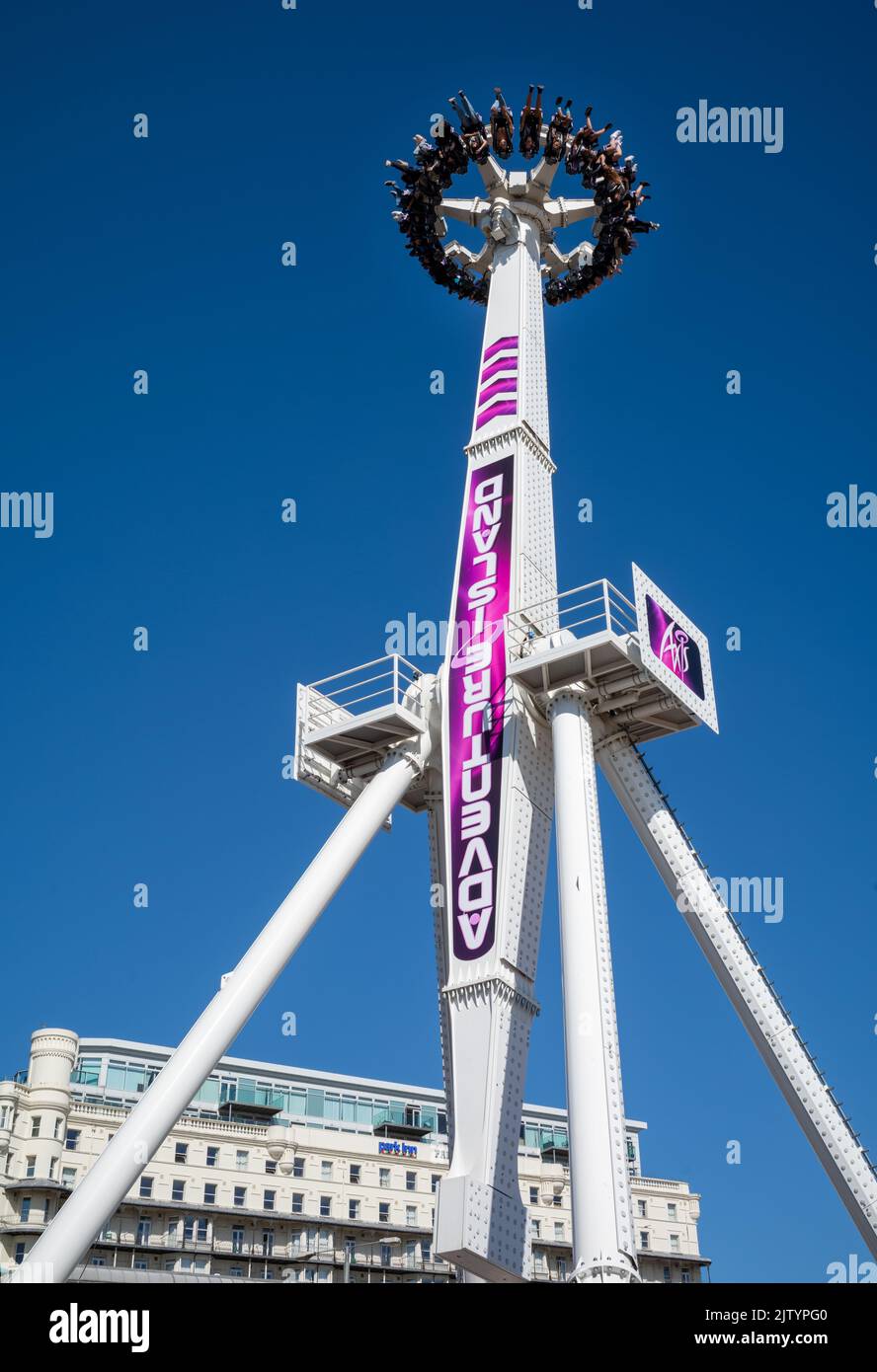 People hang upside down on a ride at Adventure Island, a funfair and ...
